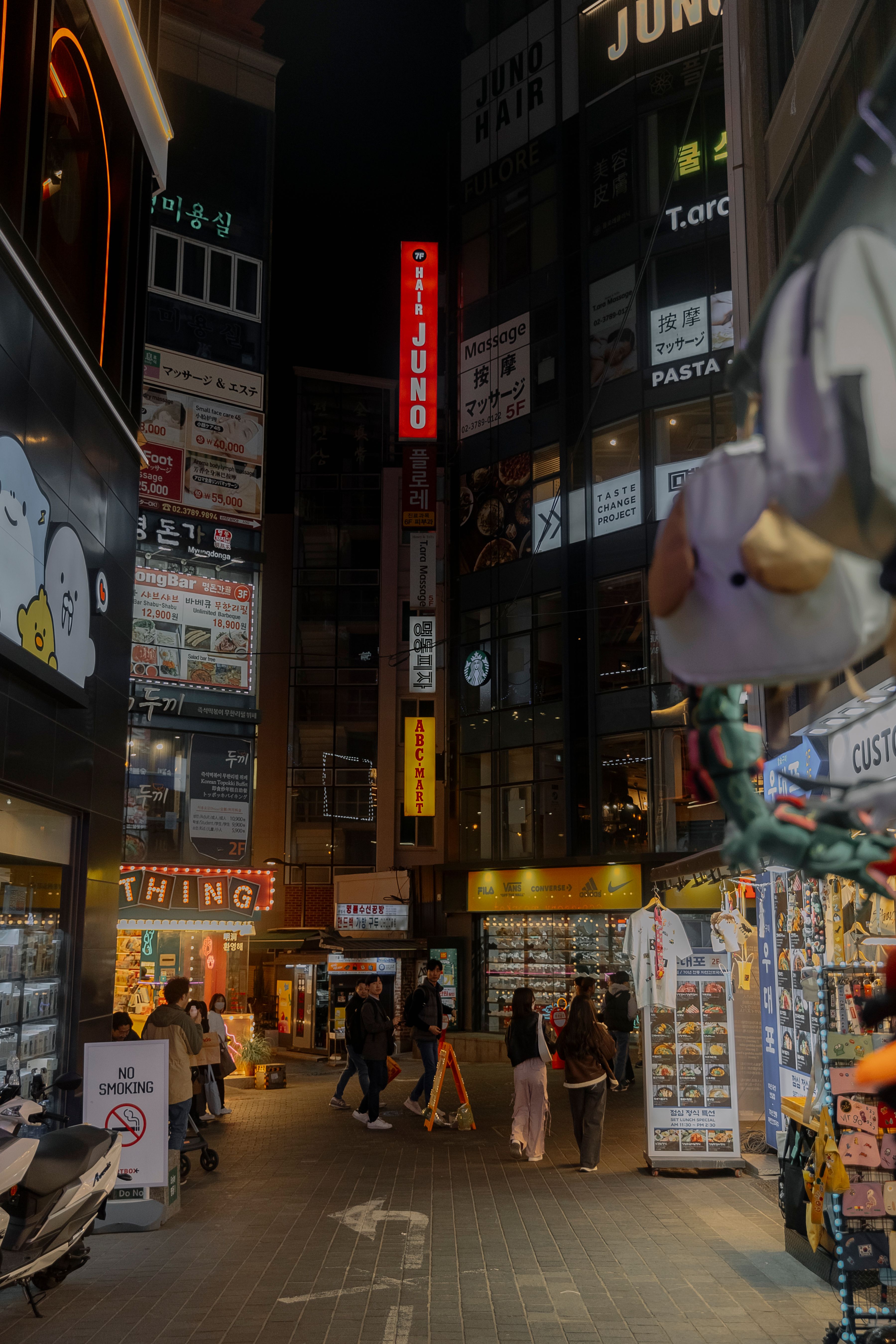 A street with many shops and people walking · Free Stock Photo