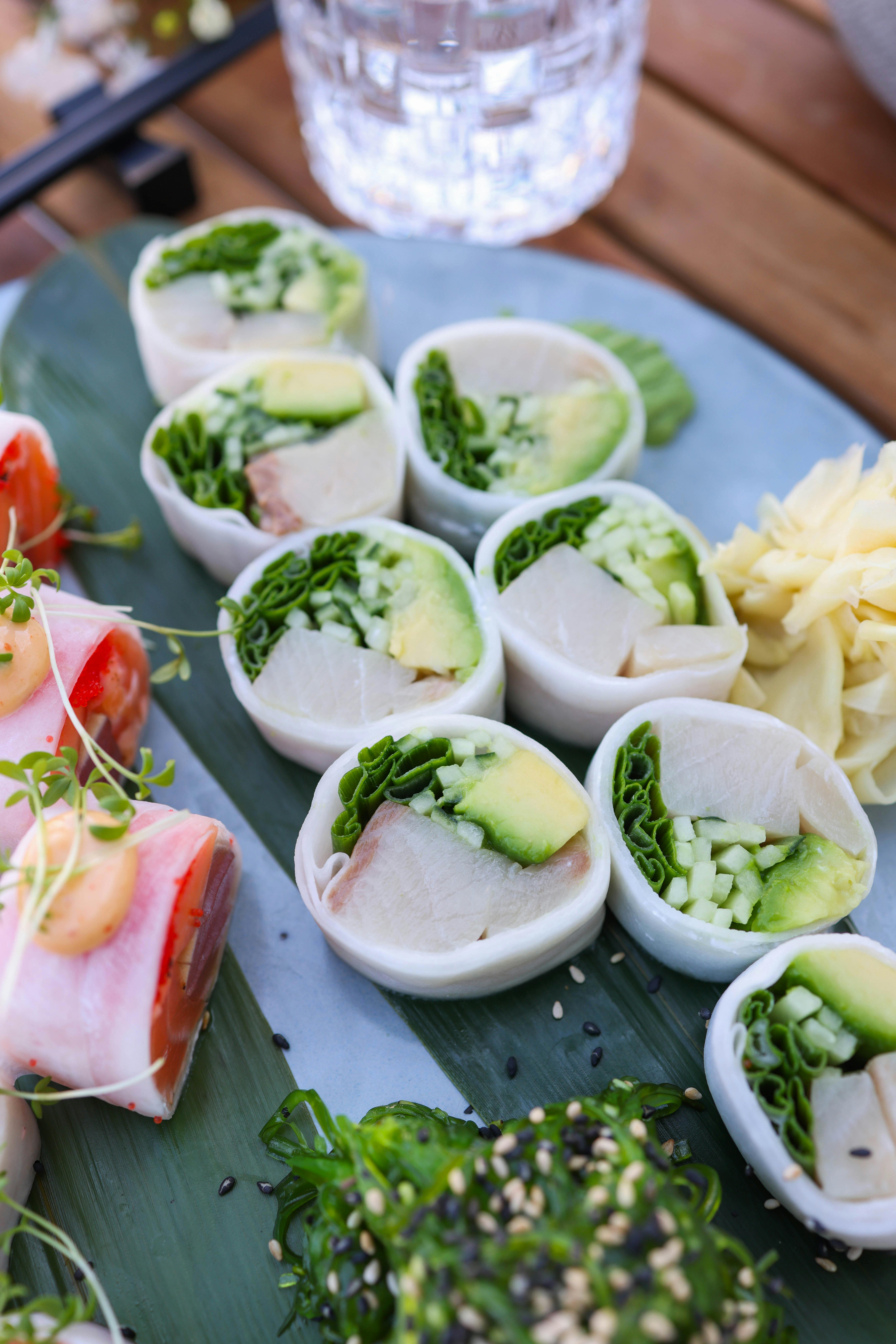 Close-up of Traditional Sashimi Rolls with Green Vegetables and Raw ...
