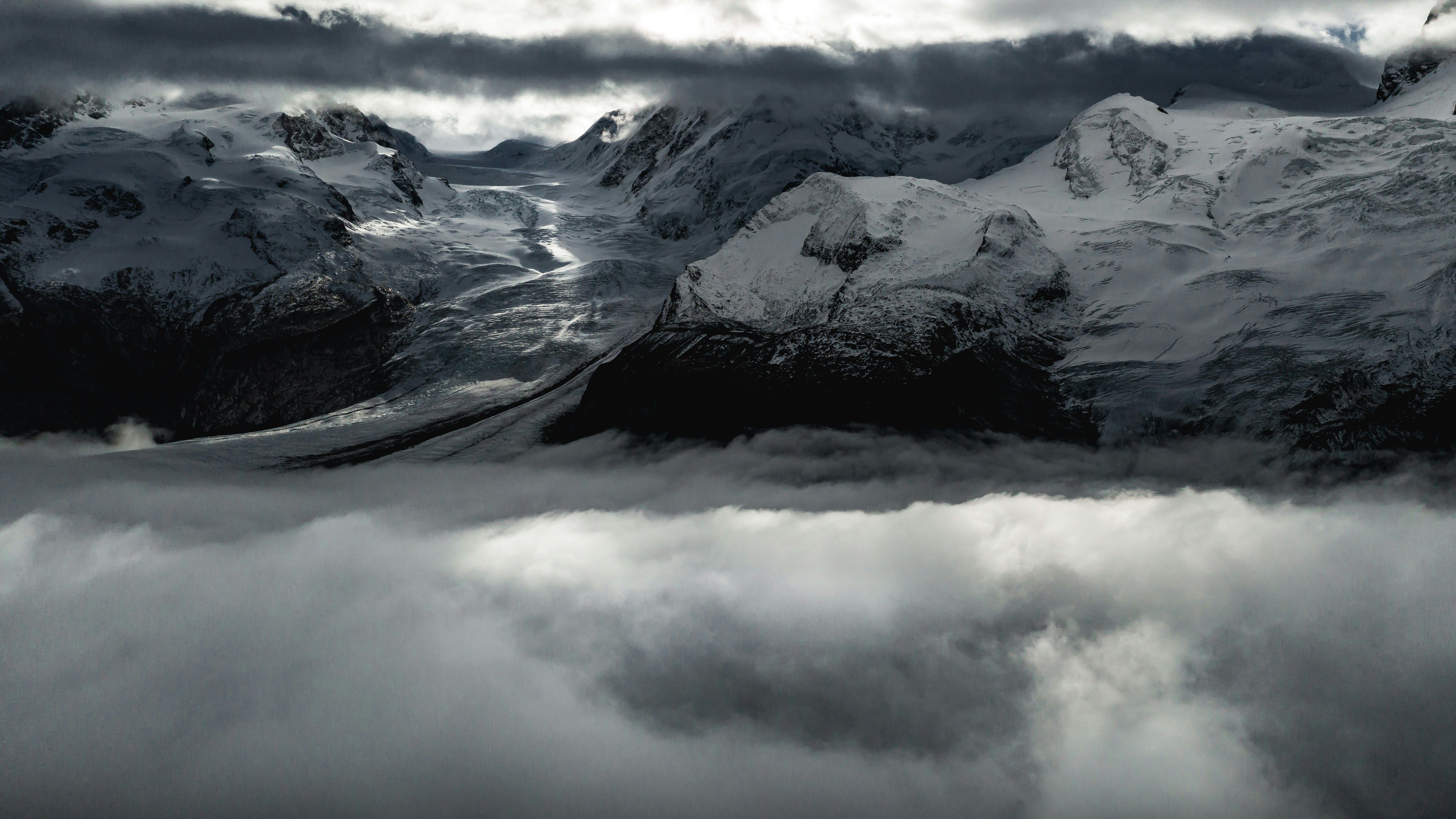 Clouds below Mountains Peaks · Free Stock Photo