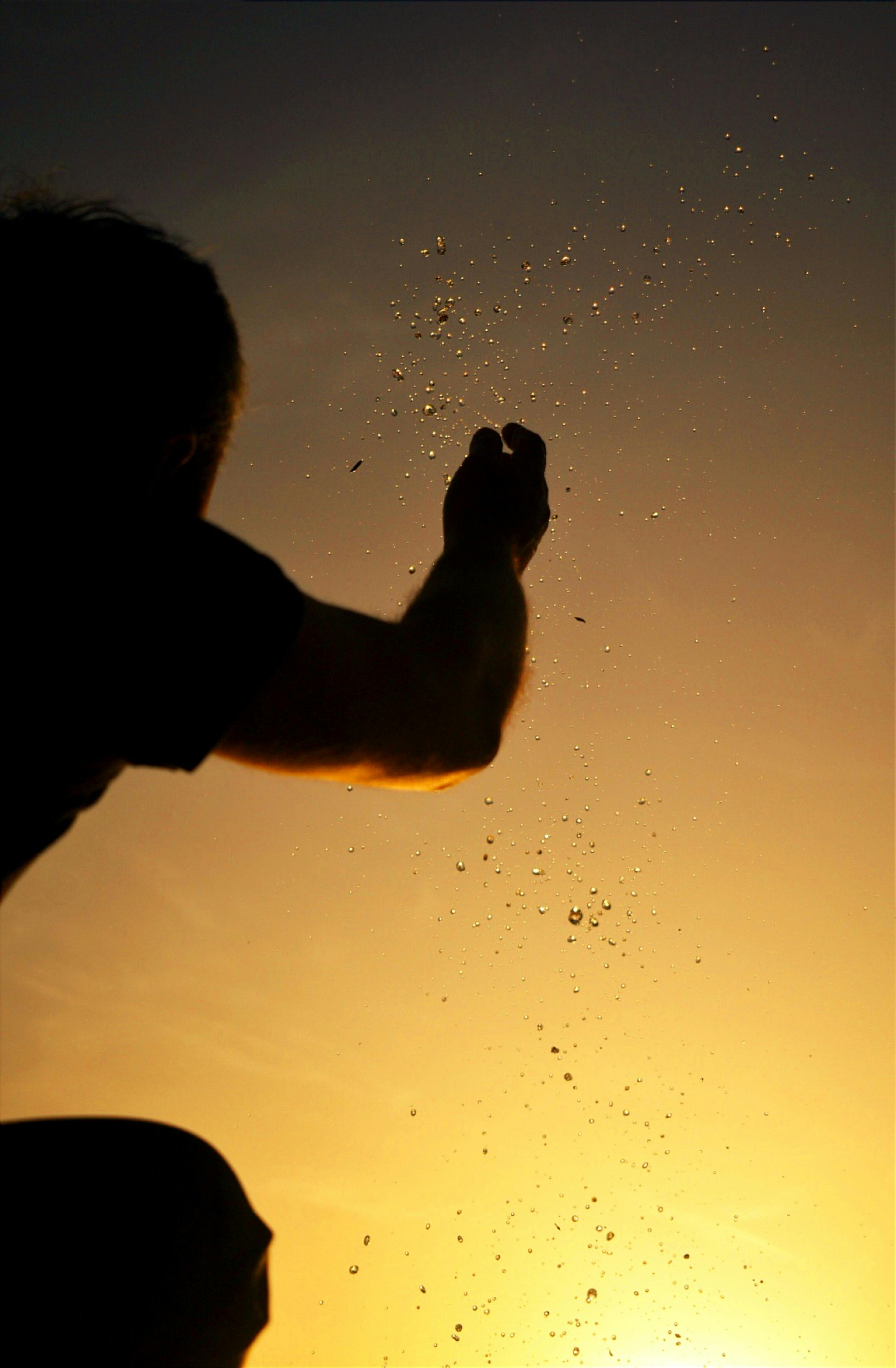 Man Throwing Water at Sunset · Free Stock Photo