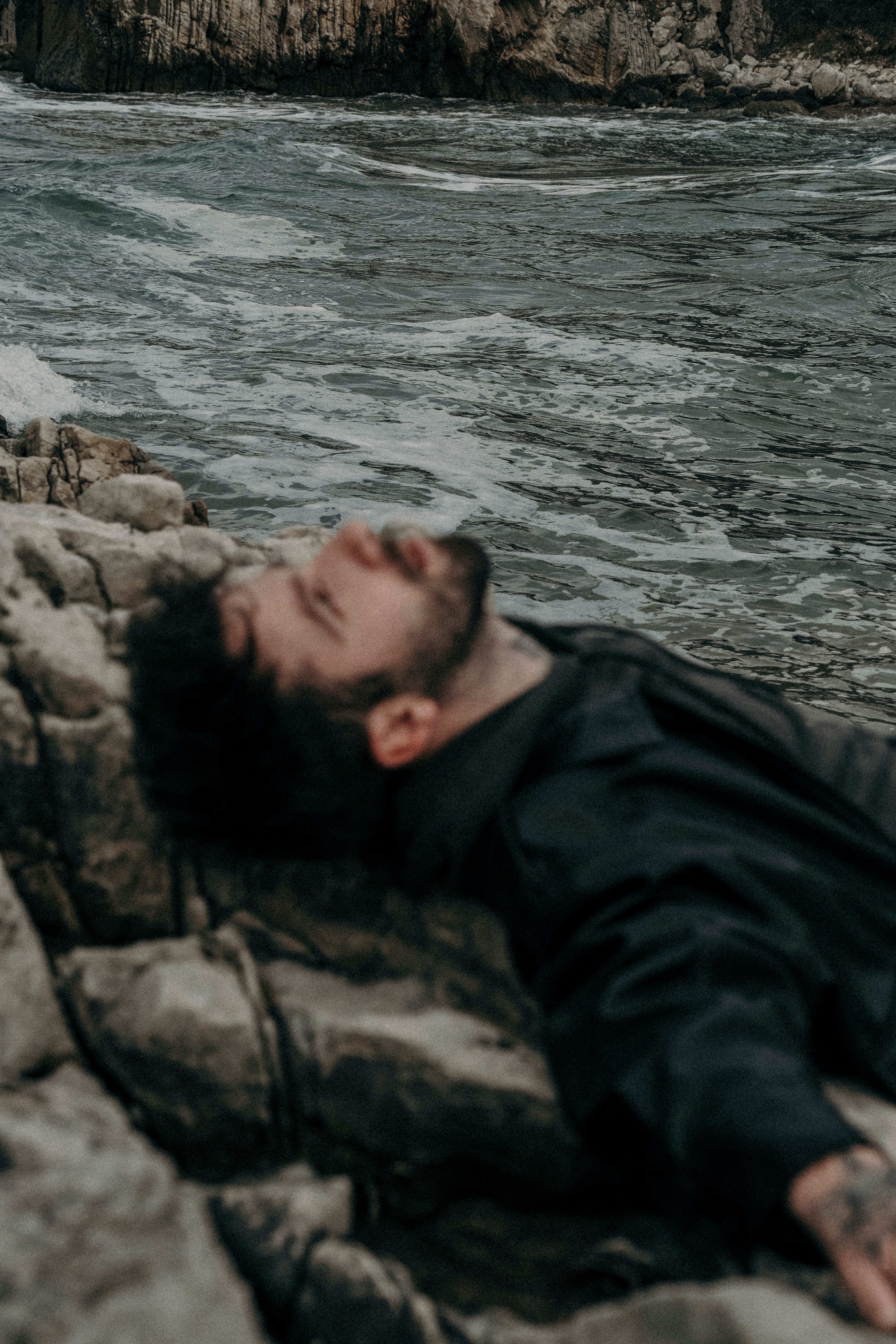 Man Lying Down on Rocks over River · Free Stock Photo