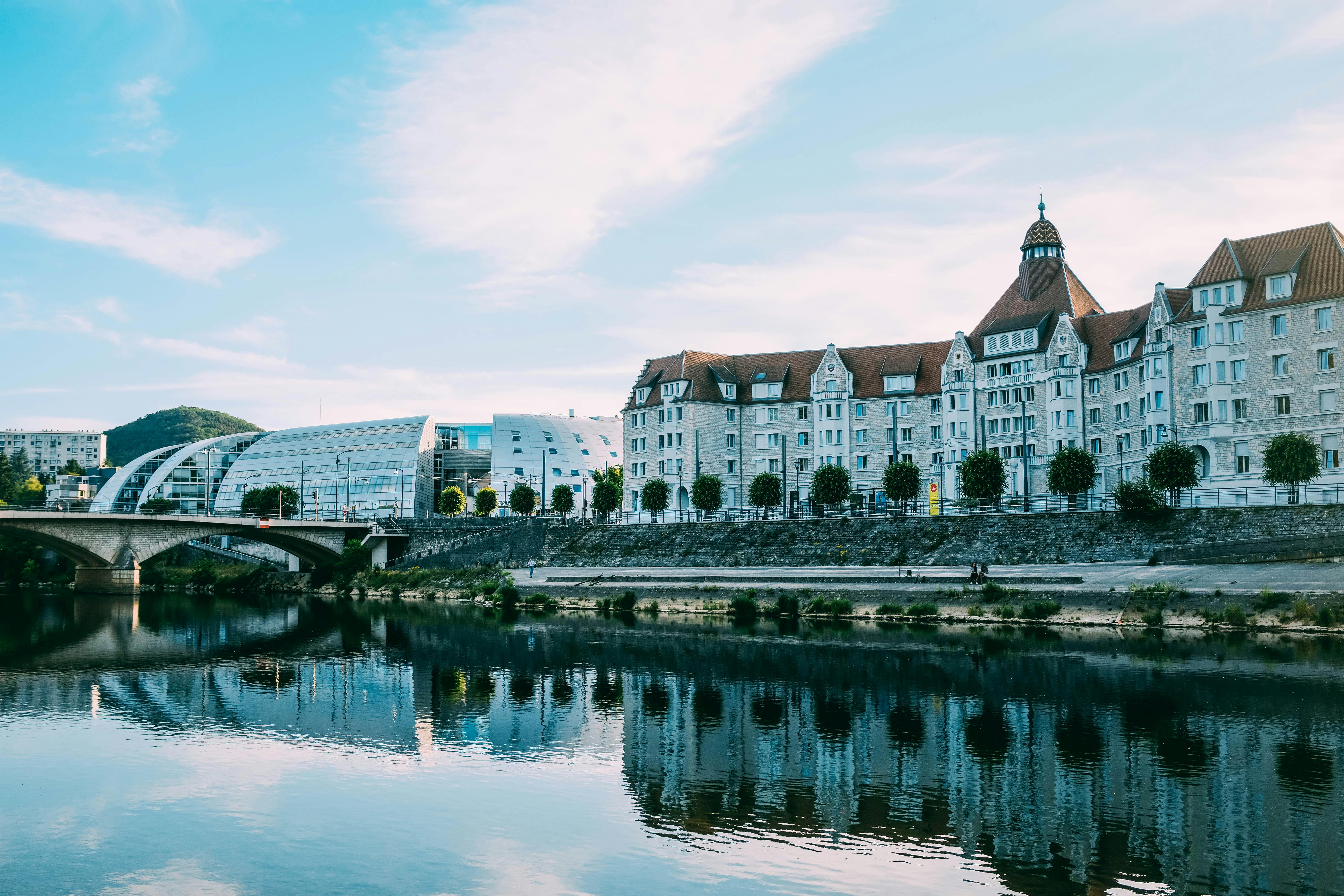 Photo of Buildings Near Trees and River · Free Stock Photo
