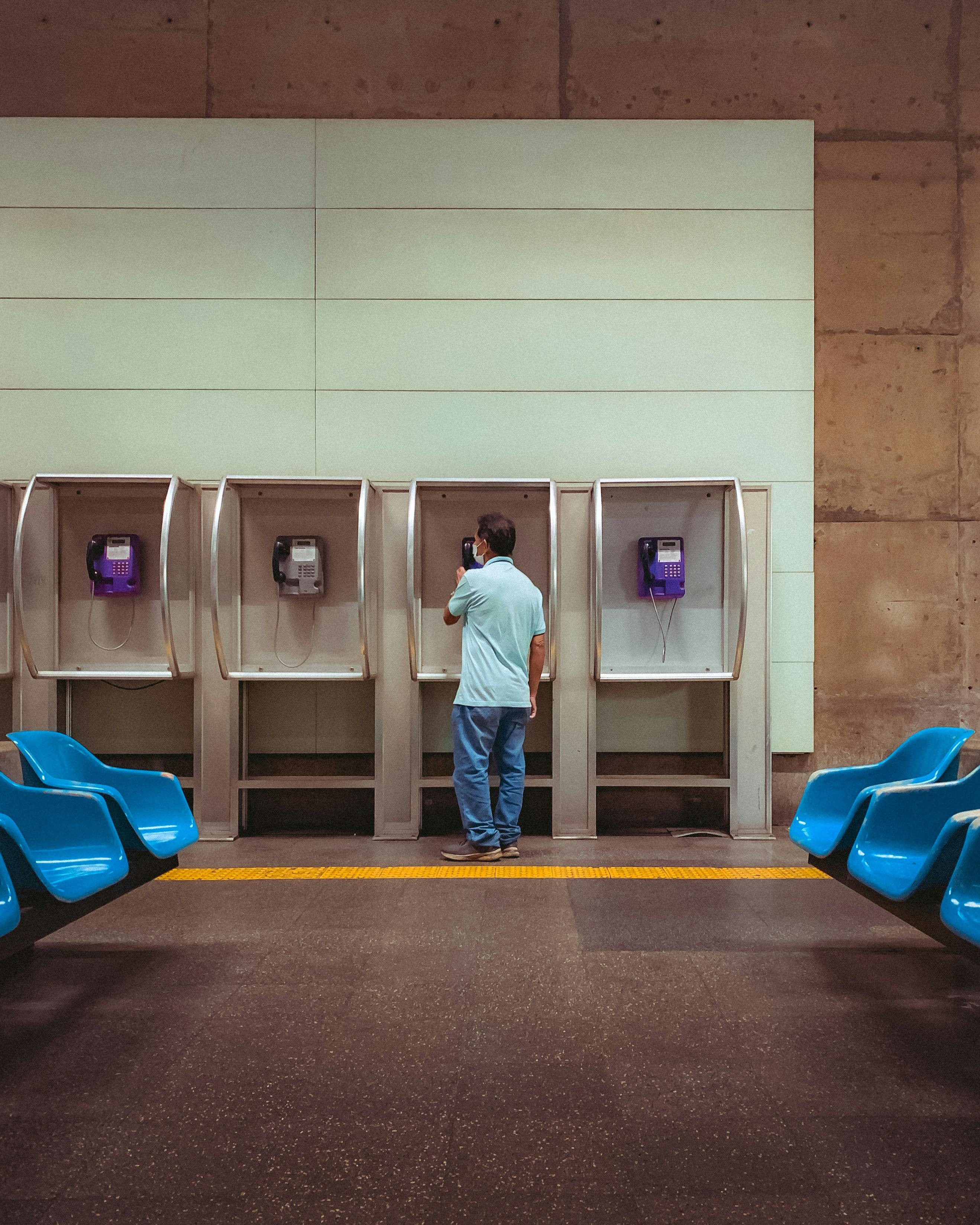 A Man Using a Payphone · Free Stock Photo