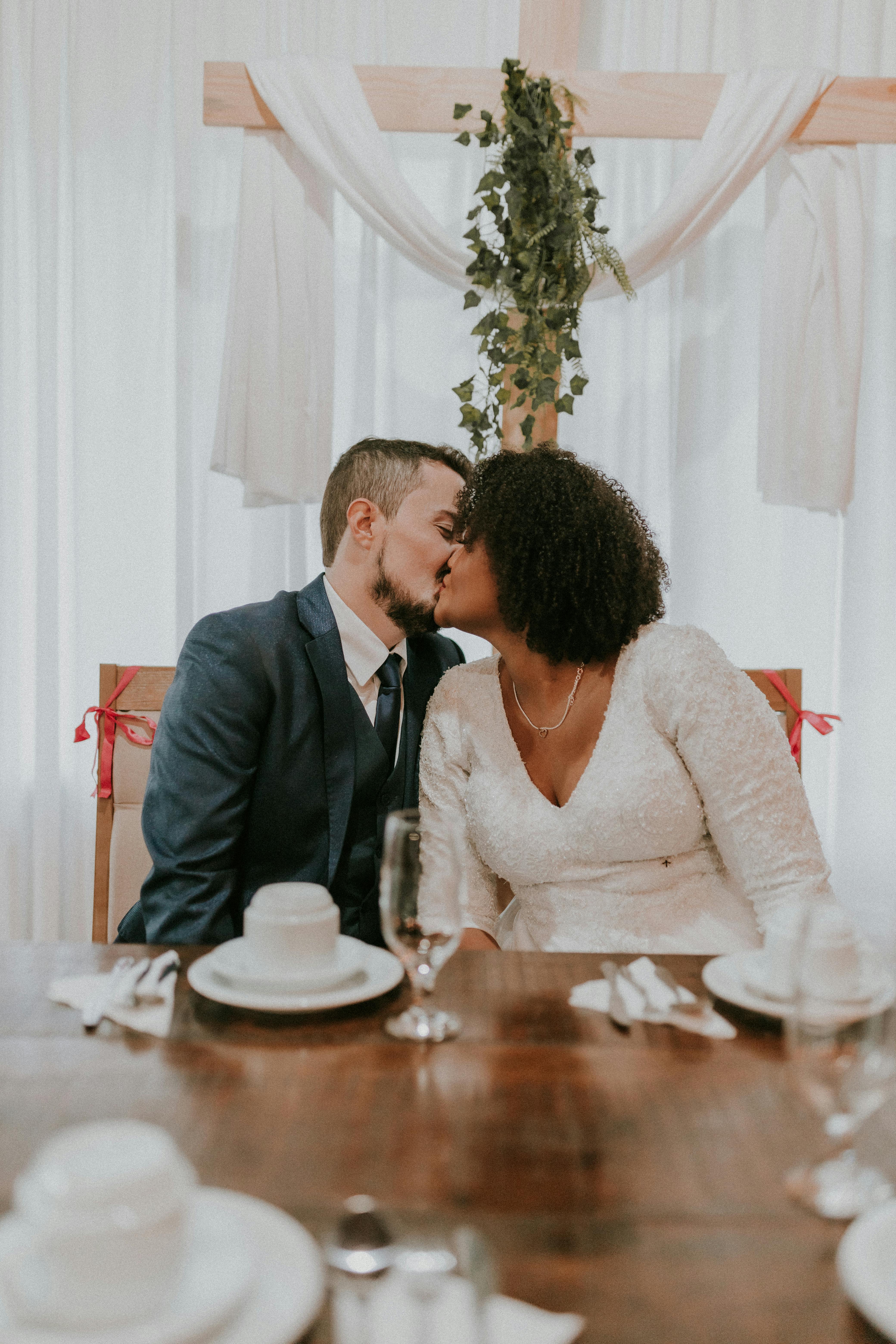 Couple Kissing at the Dining Table · Free Stock Photo