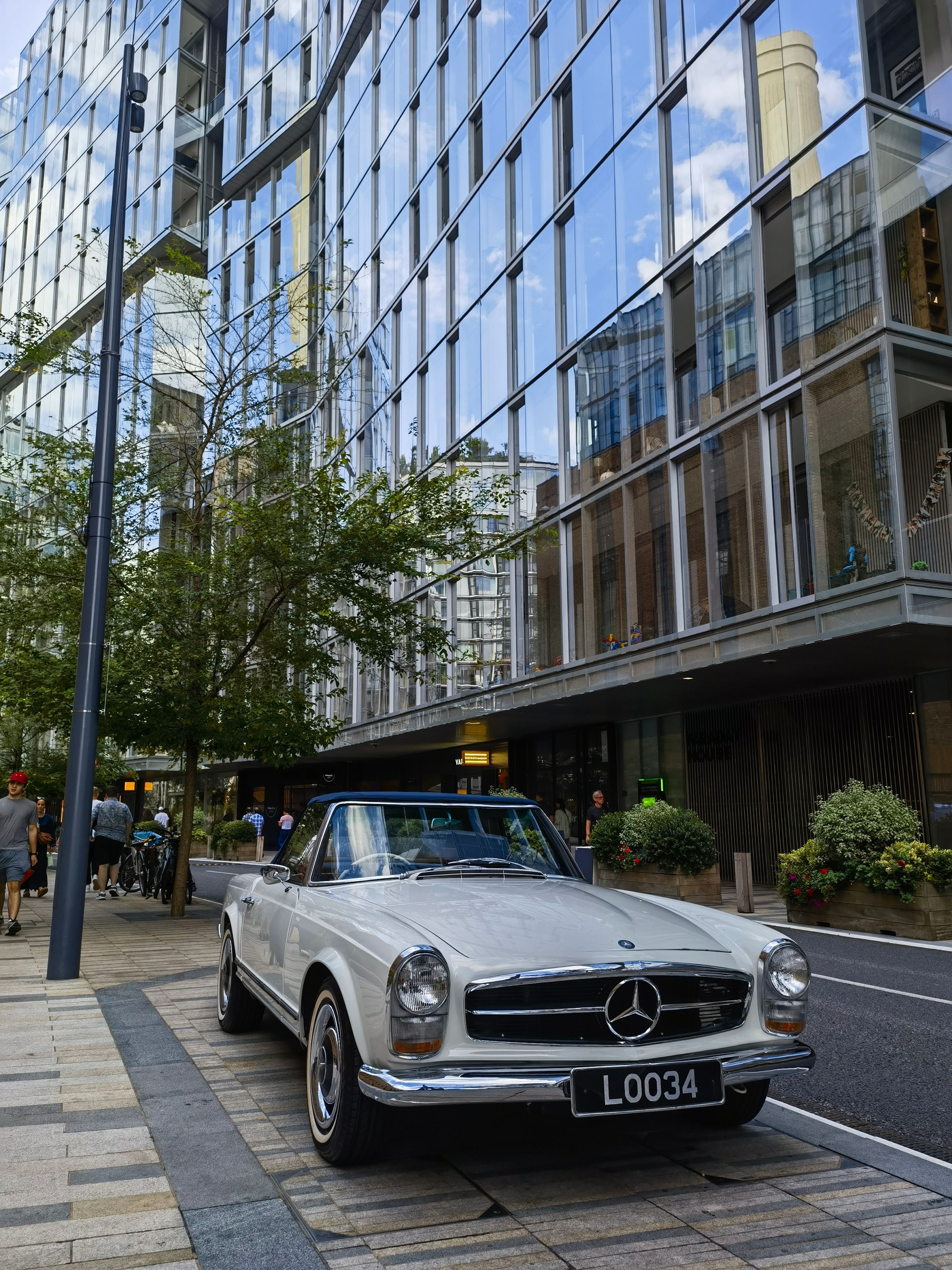 Traditional Silver Mercedes Car Against Urban Background · Free Stock Photo