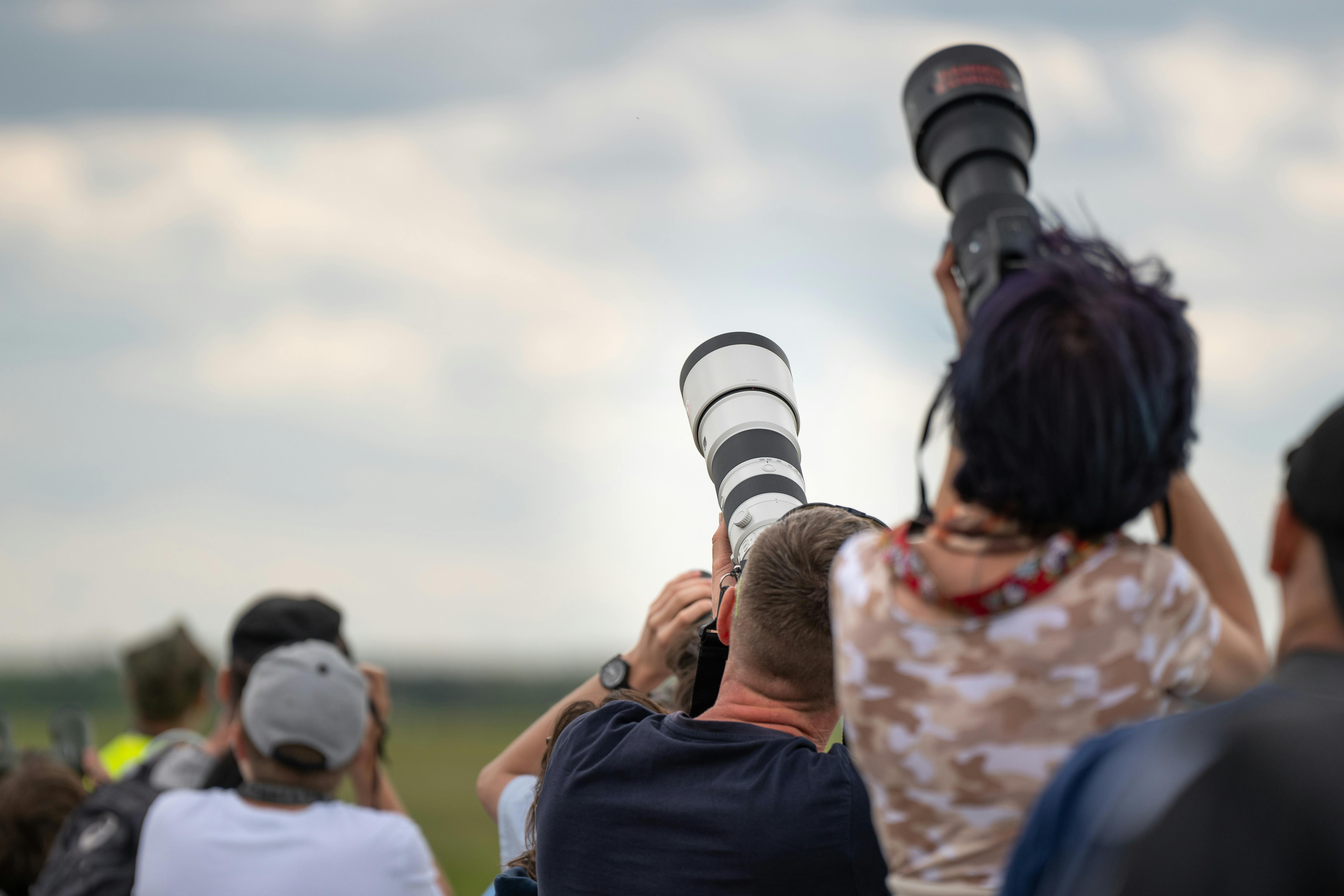 People Looking Through Lenses to the Air · Free Stock Photo