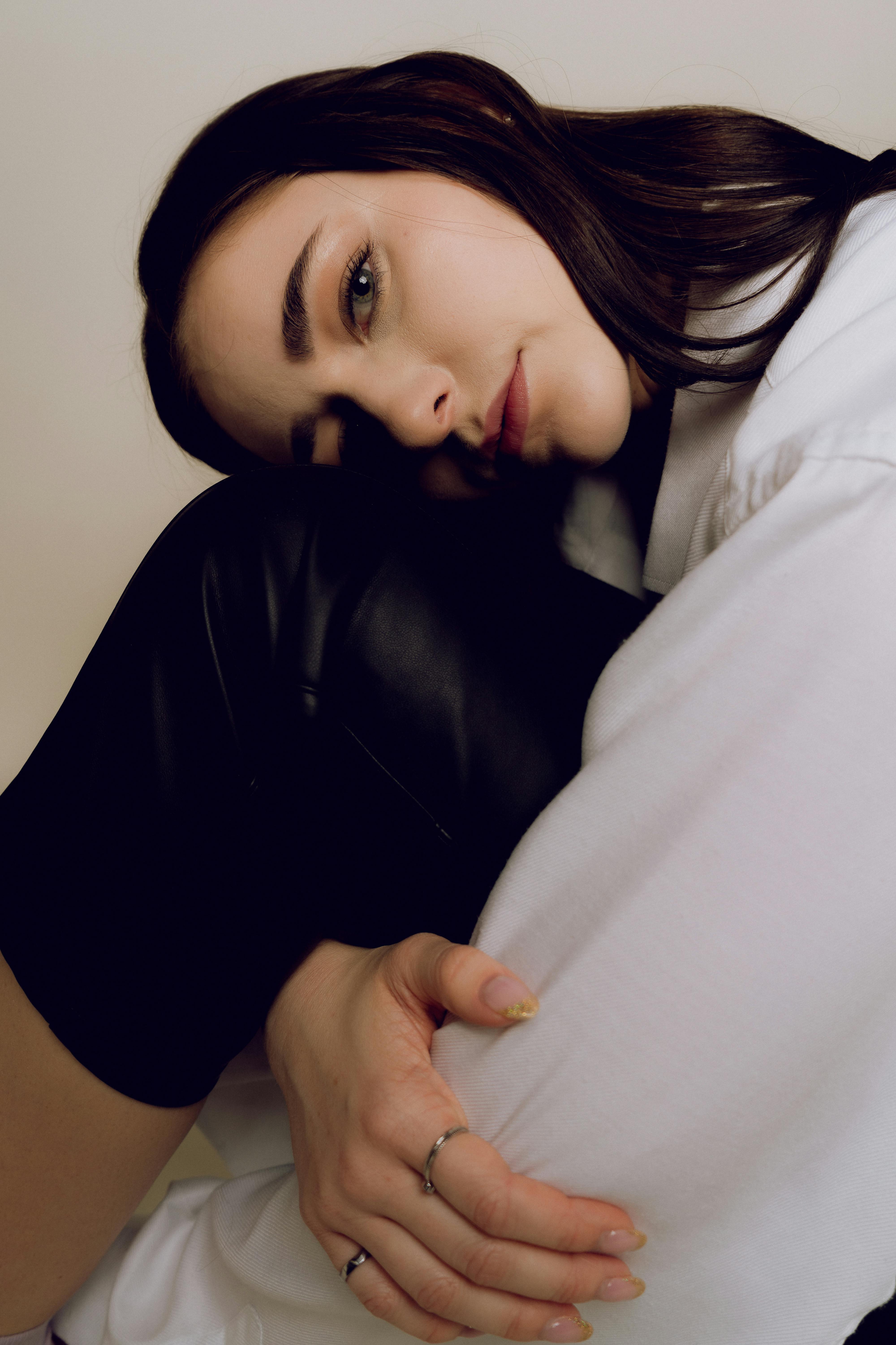 Woman Sitting in Introspective Pose · Free Stock Photo