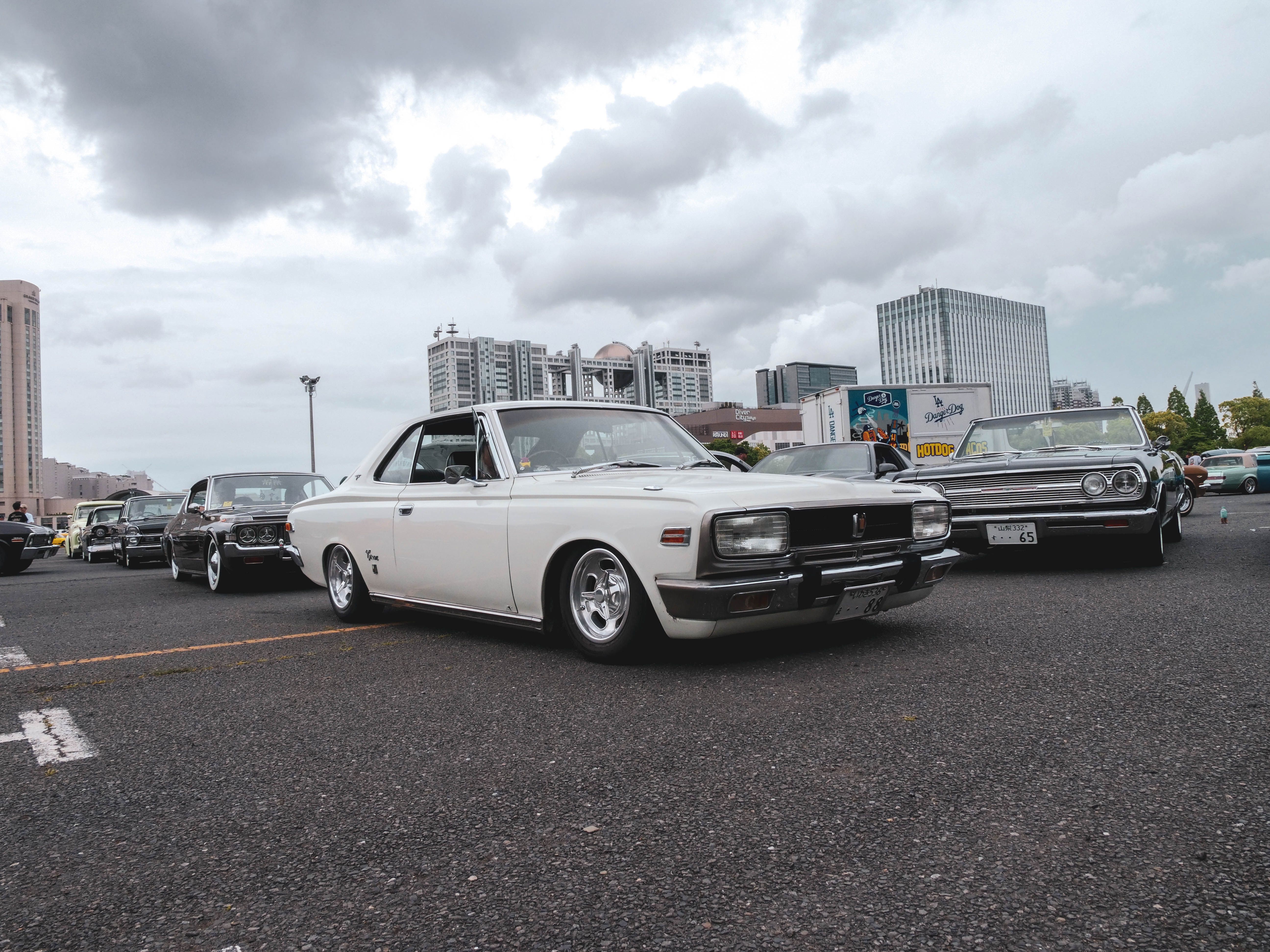 A white car parked in a parking lot · Free Stock Photo