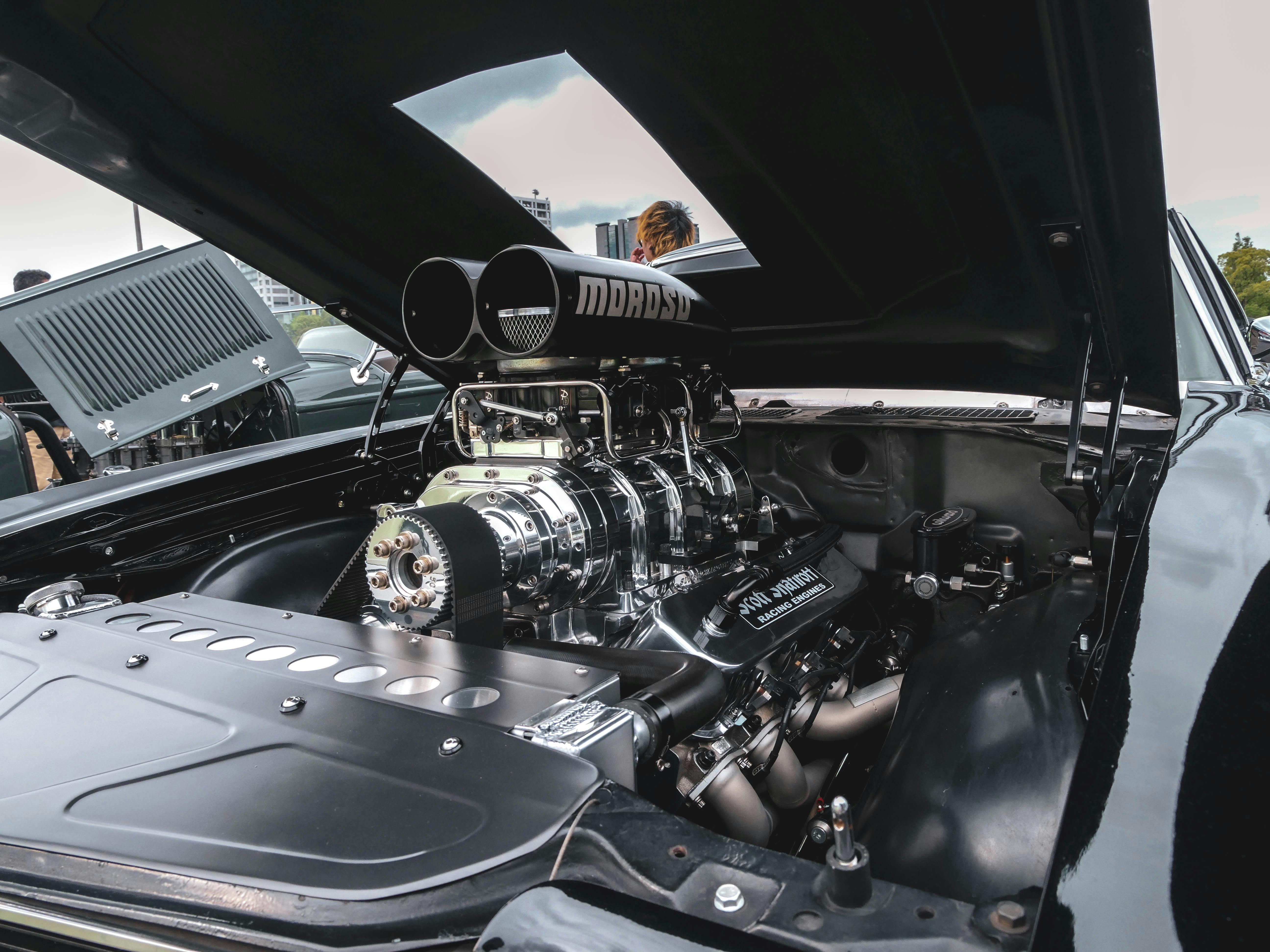 A black car with a large engine in the front · Free Stock Photo