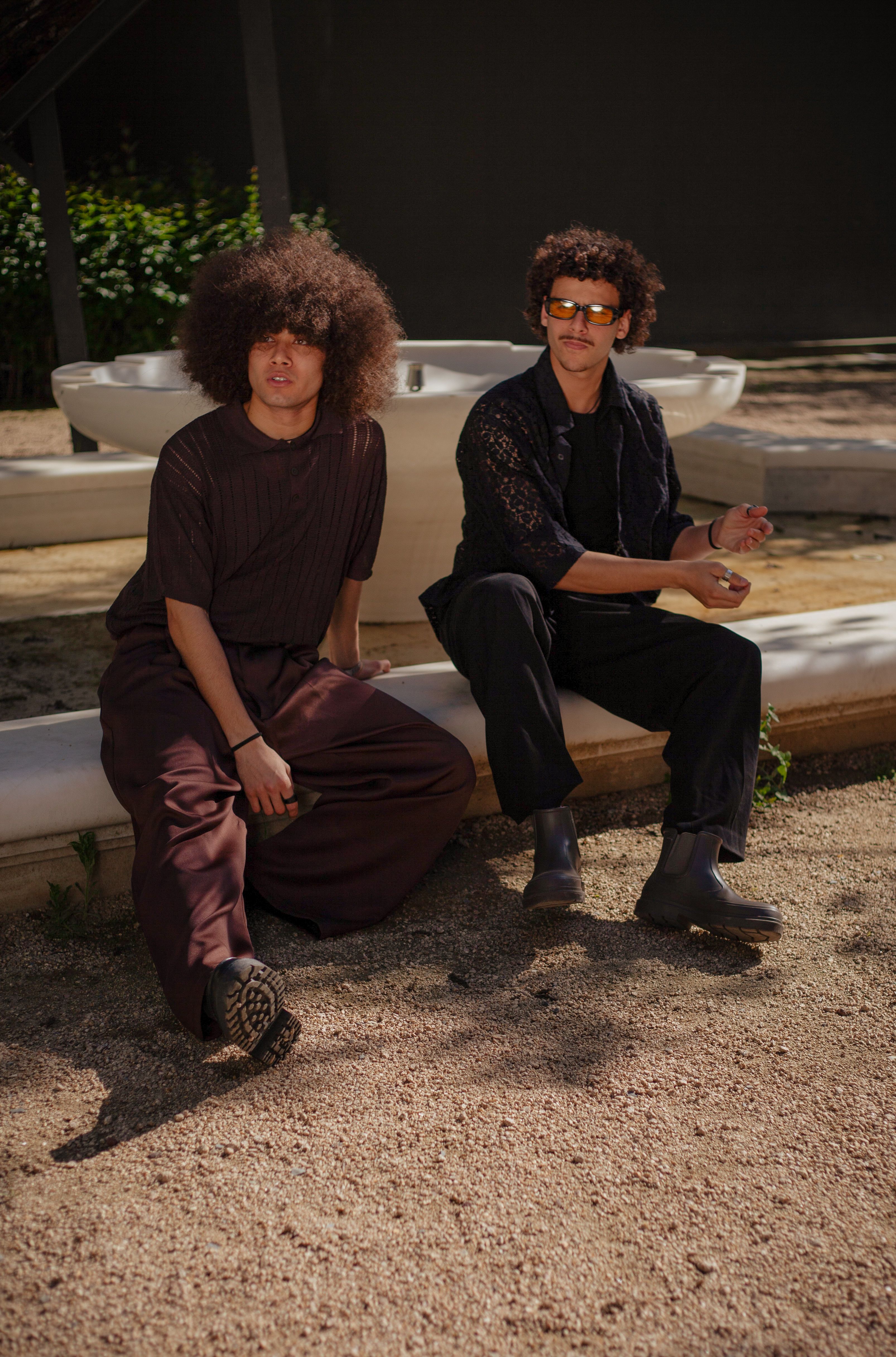 Two Men Sitting Outdoors · Free Stock Photo