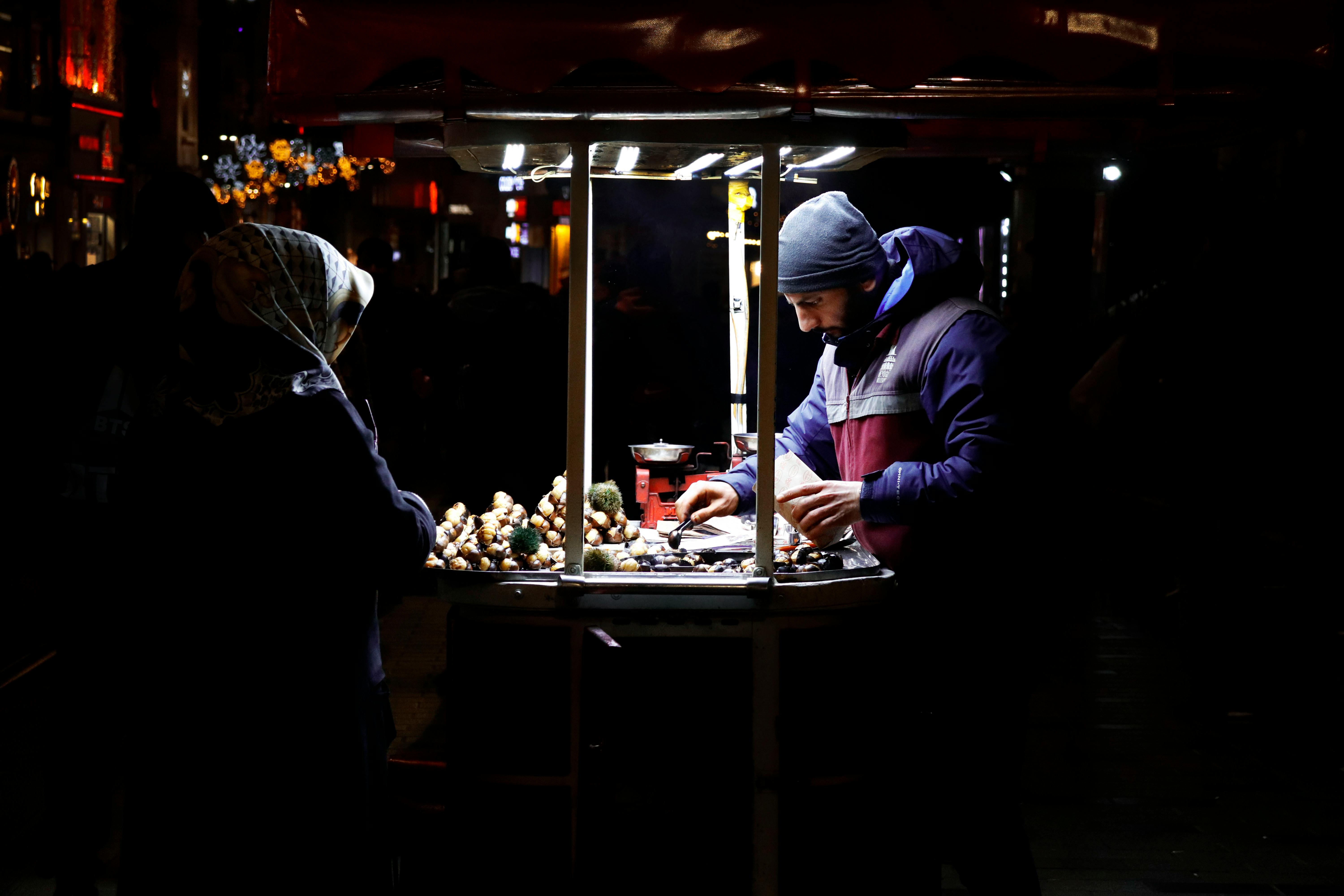 Street Food Stall next to Restaurant at Night · Free Stock Photo