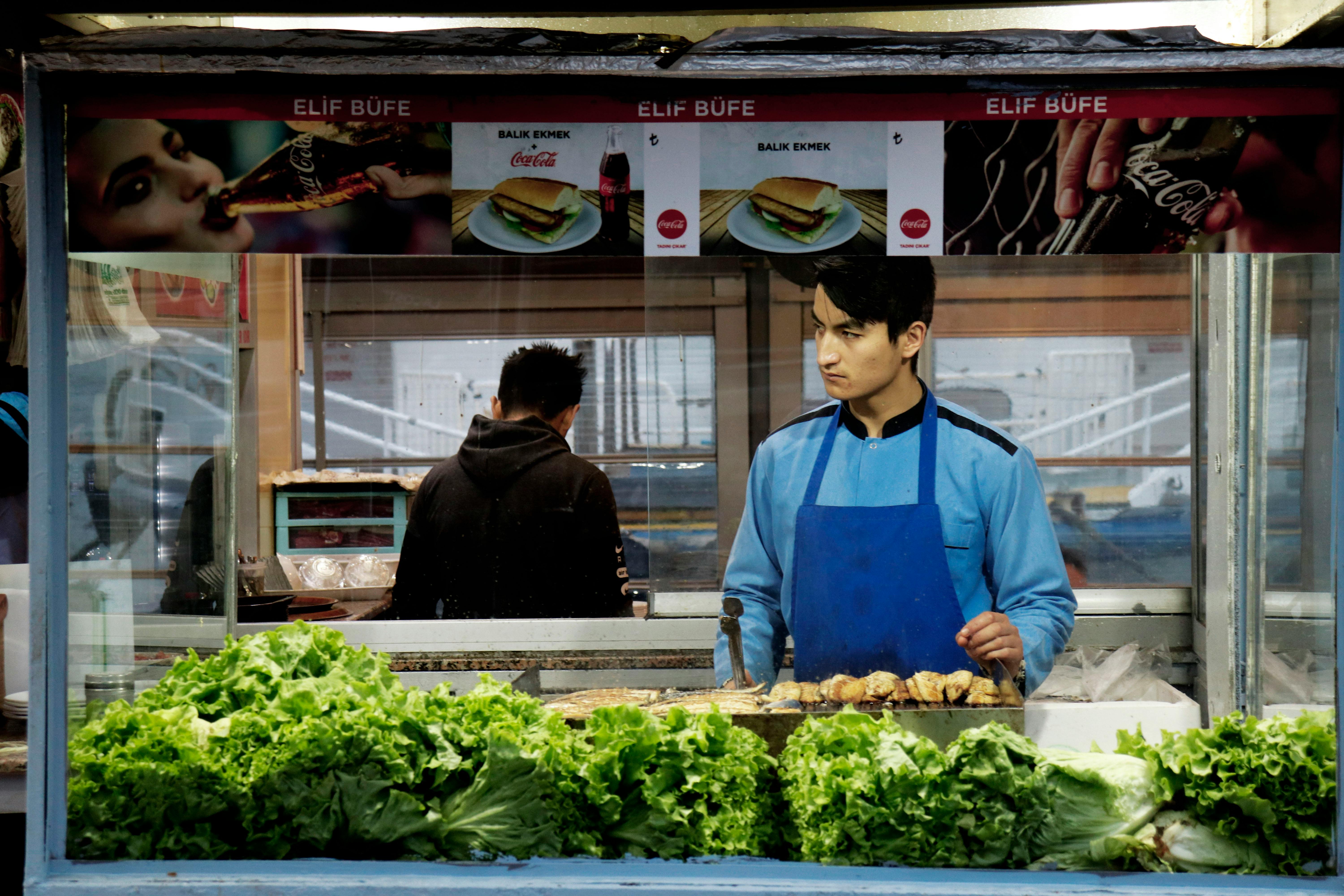 Street Vendor at a Sandwich Stall · Free Stock Photo