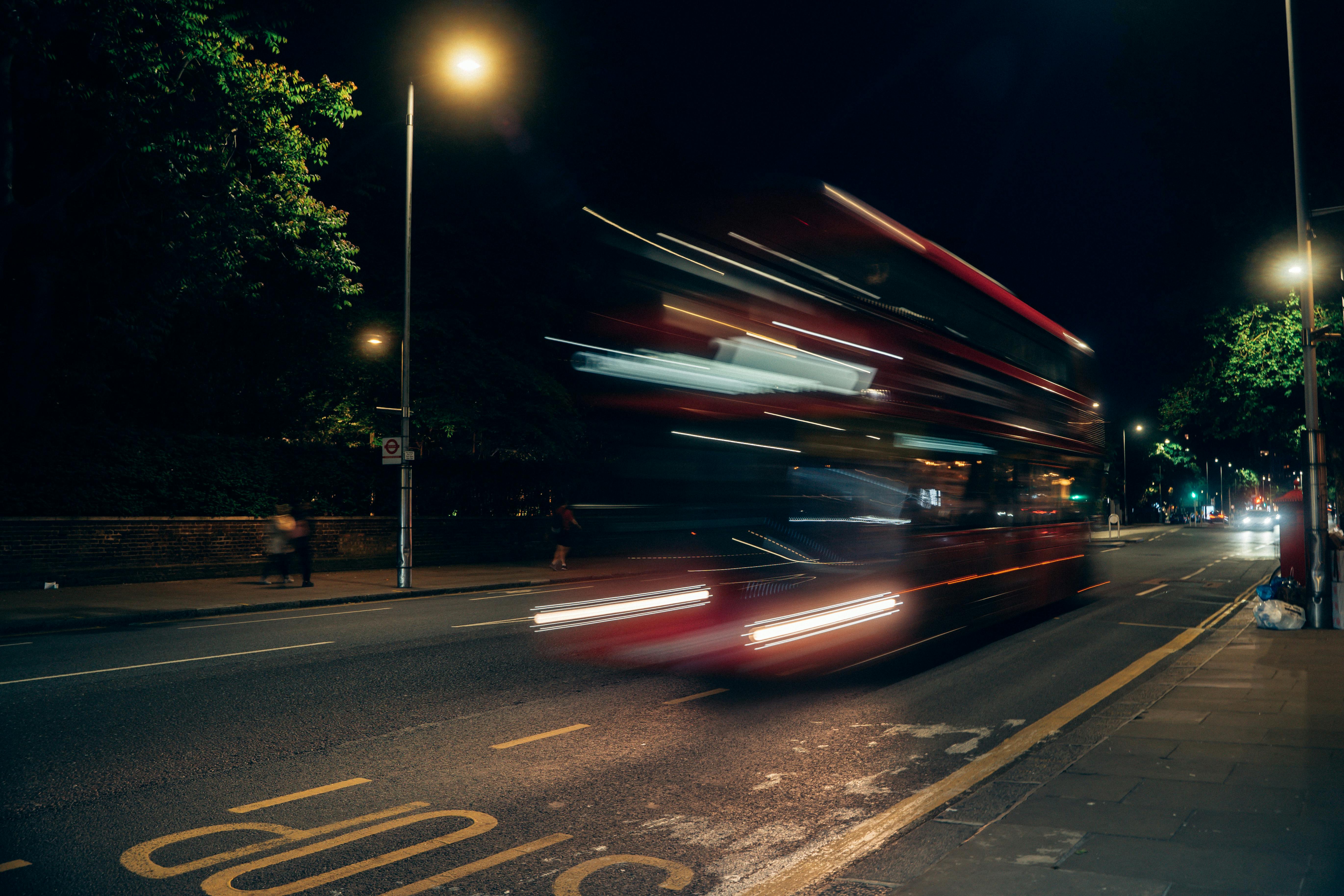 Bus Driving Fast on the Street at Night · Free Stock Photo