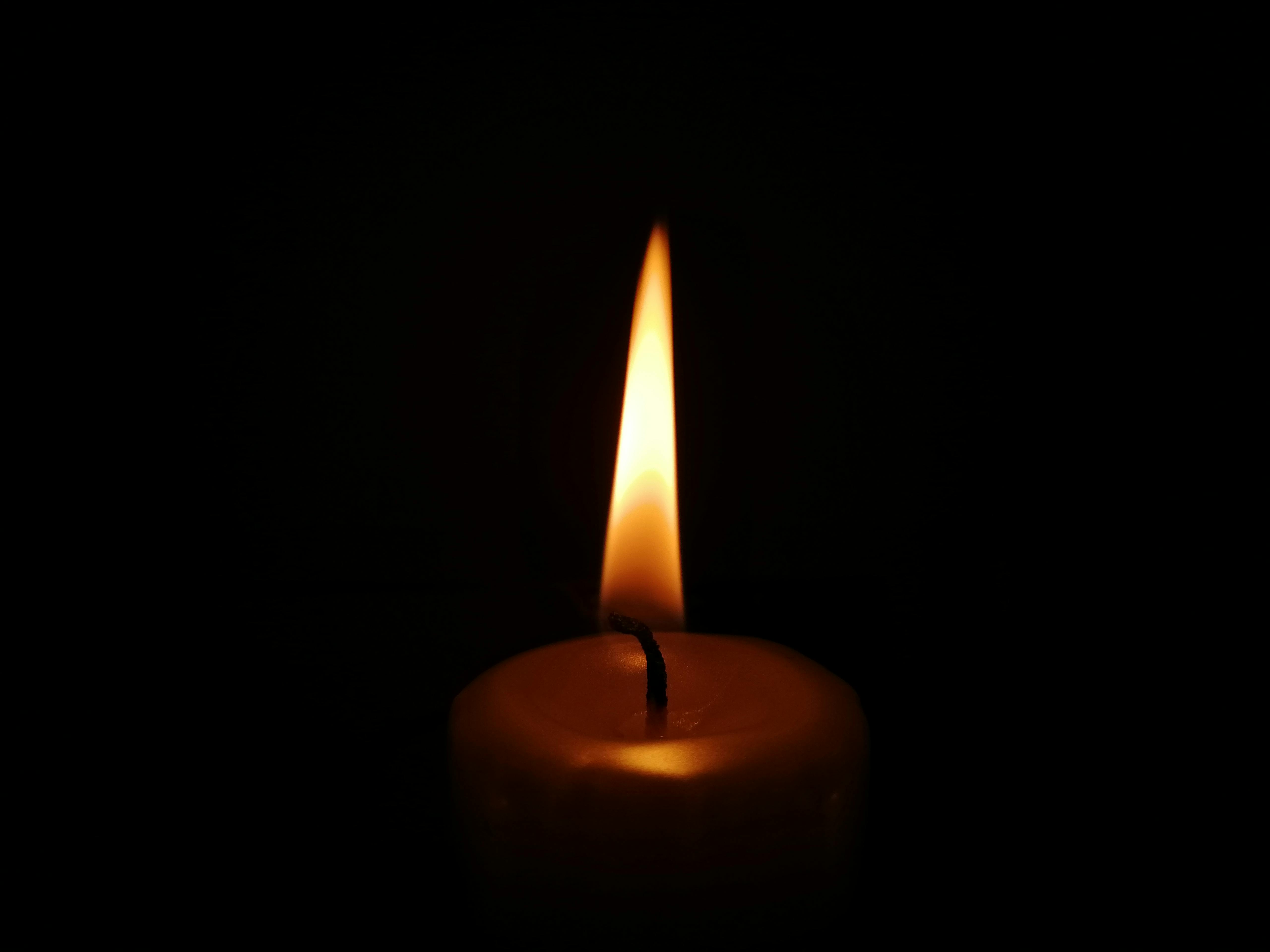 Candle Lit Against Black Background · Free Stock Photo