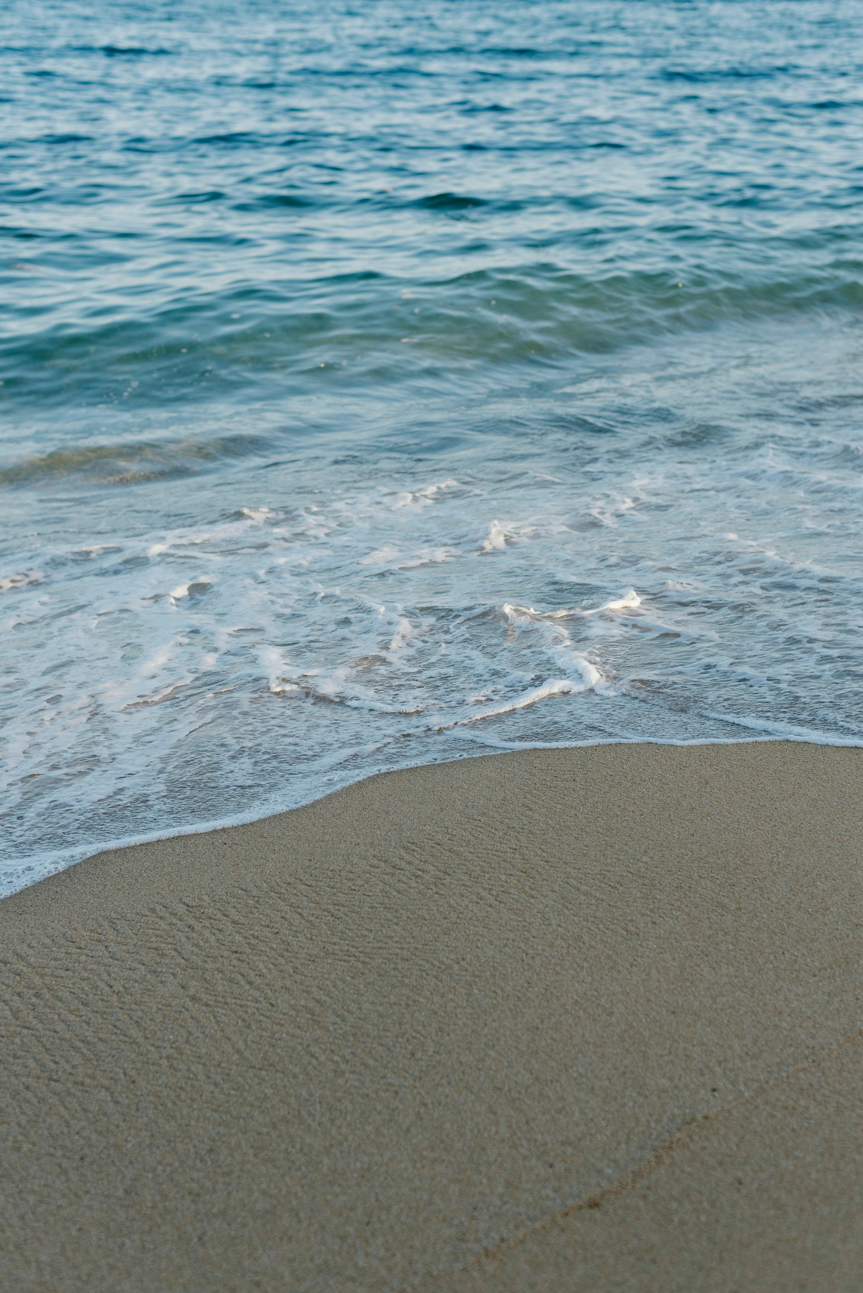 Calm Water on Seashore at Daytime · Free Stock Photo