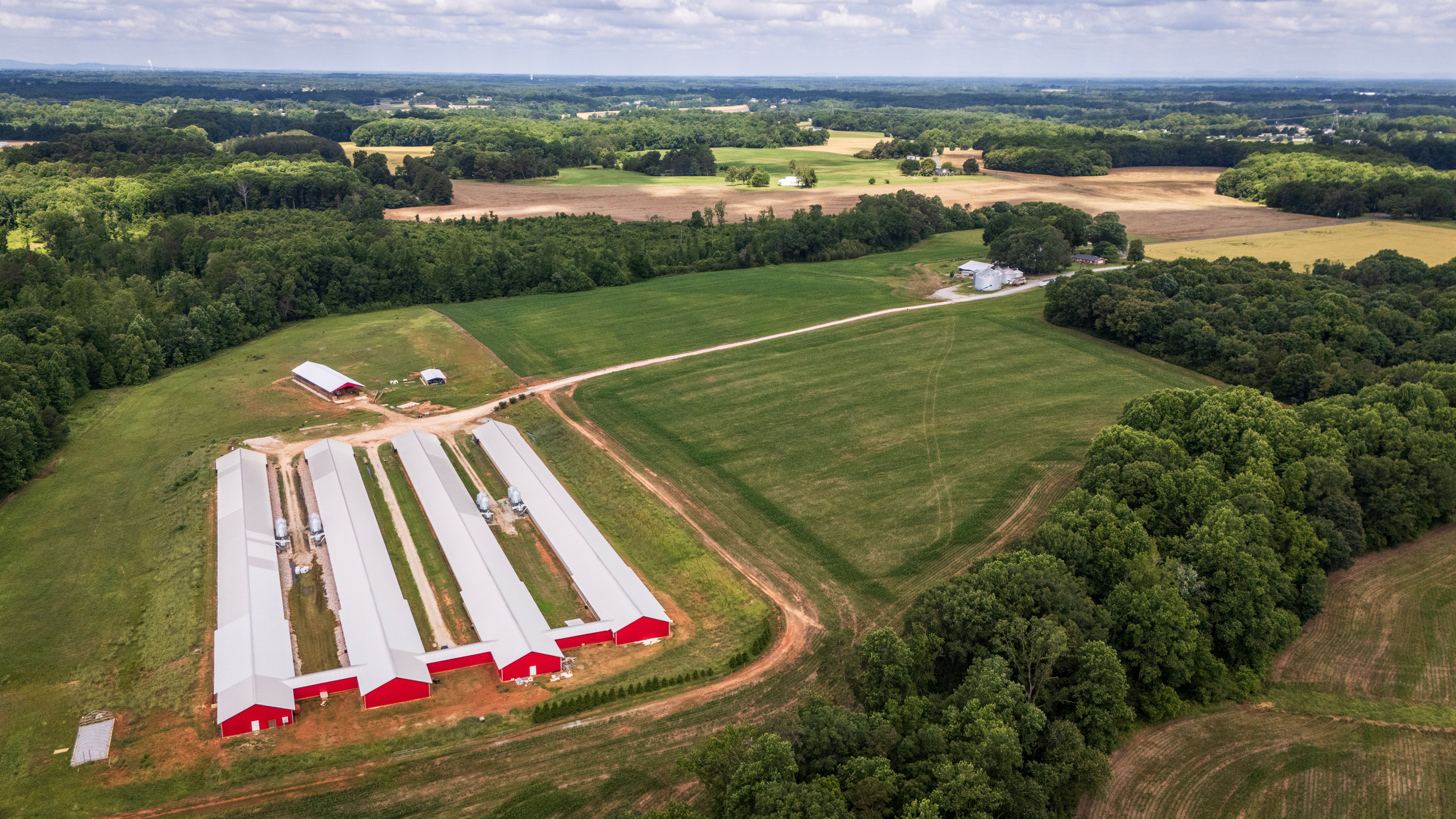 An aerial view of a farm with a large red barn · Free Stock Photo