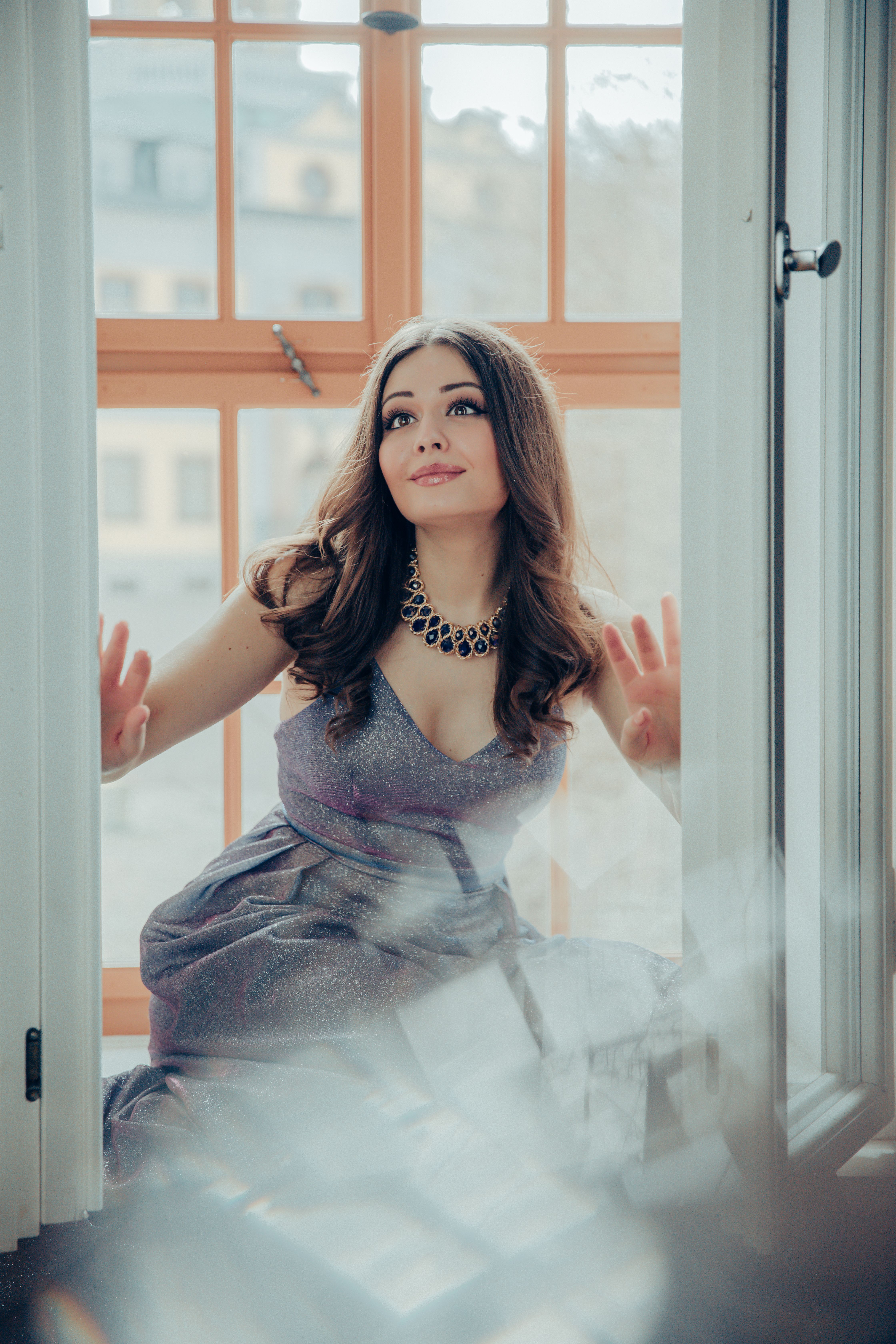 Woman Sitting in the Window · Free Stock Photo