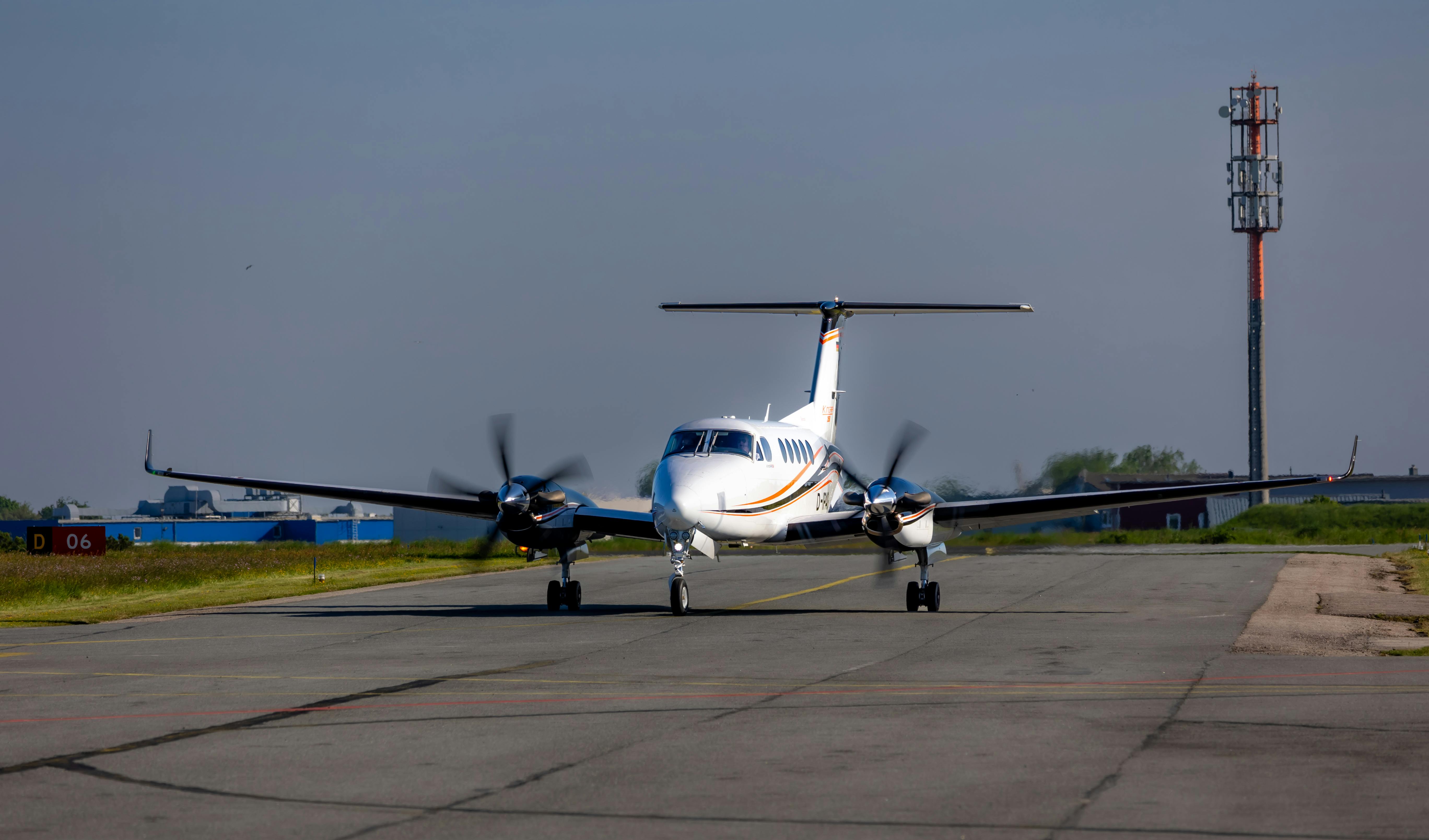 A small propeller plane sitting on the runway · Free Stock Photo