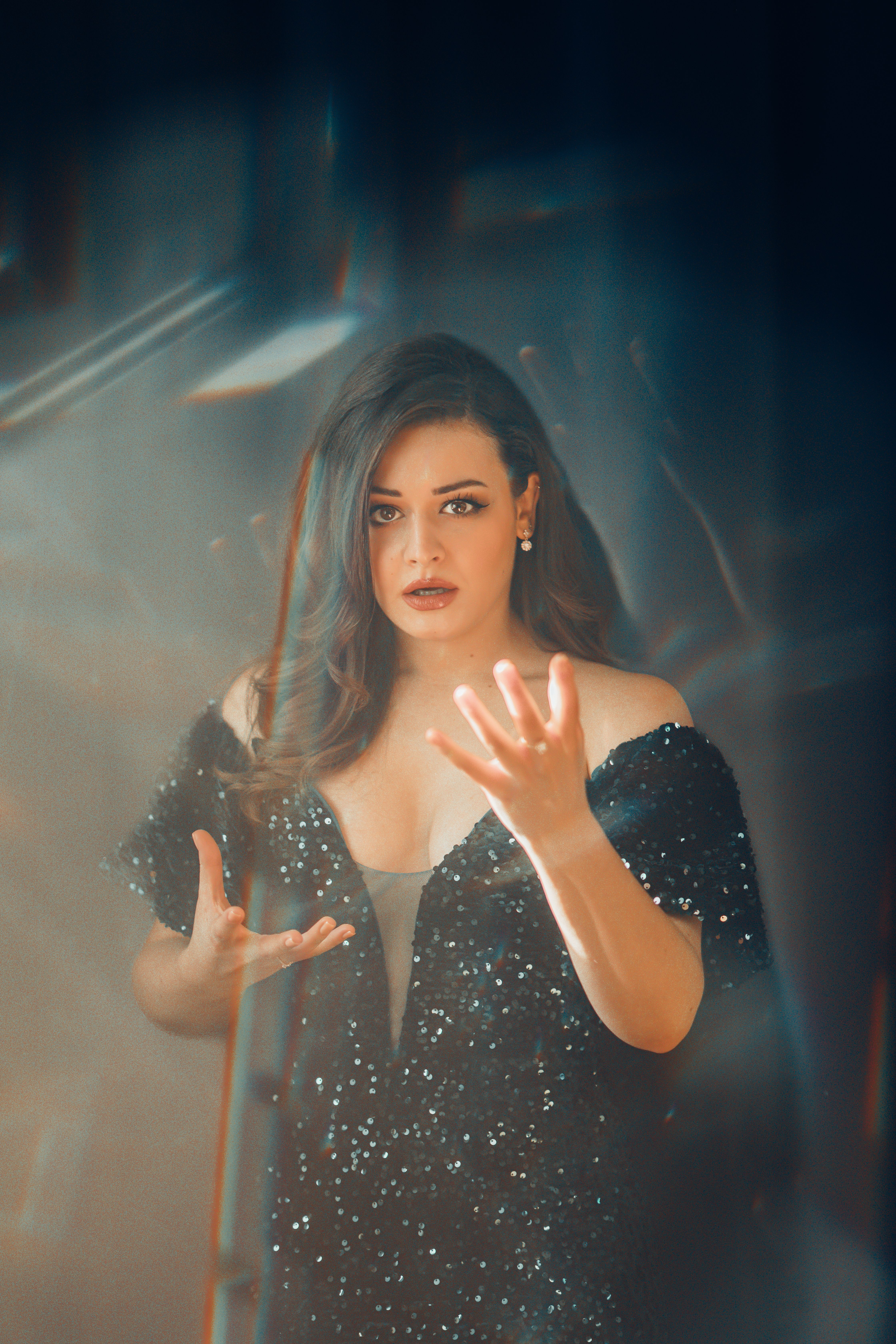 Portrait of a Female Model Wearing a Black Sequin Dress Gesturing ...