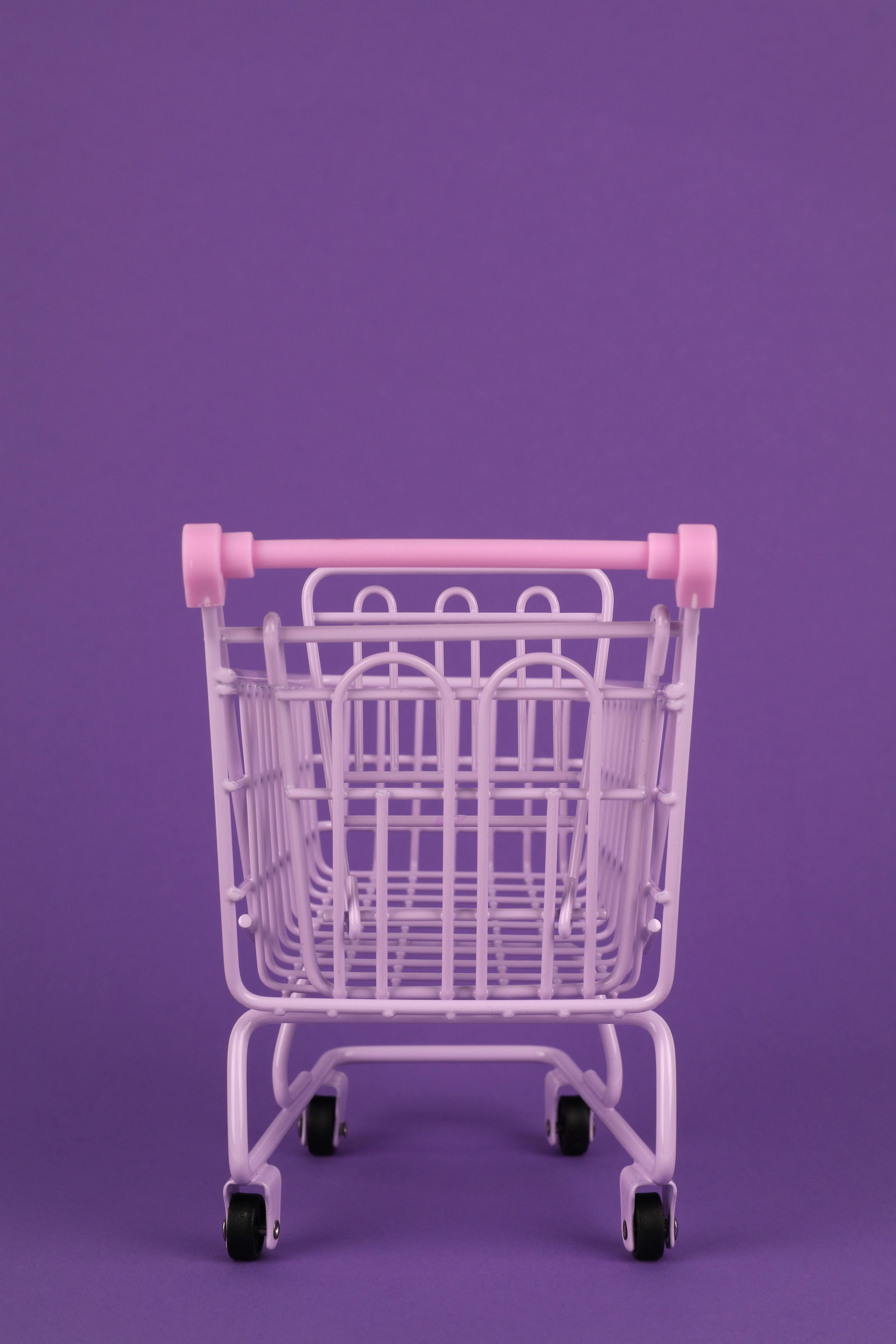 Empty Shopping Cart against a Purple Background · Free Stock Photo