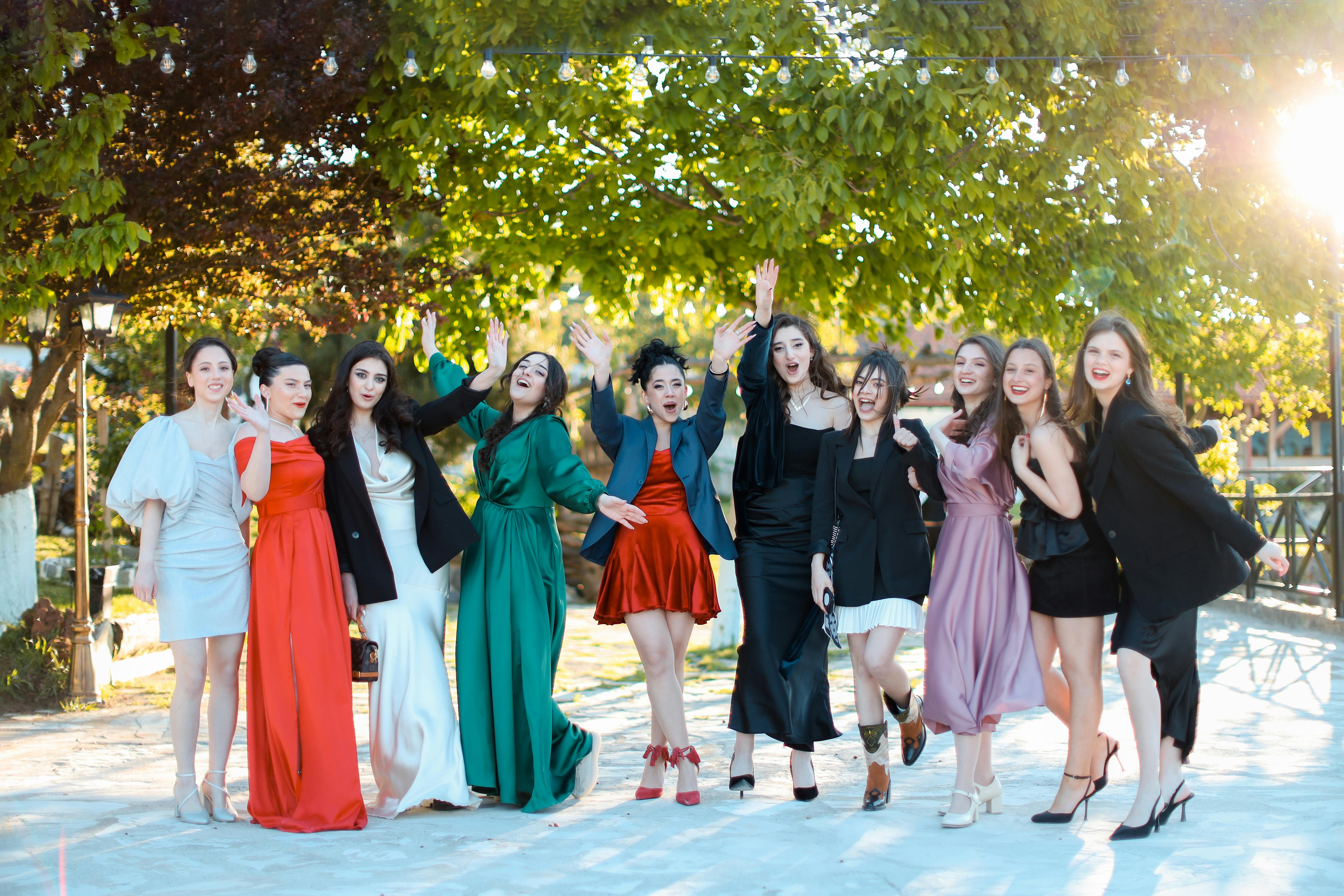 A group of women in formal dresses posing for a photo · Free Stock Photo