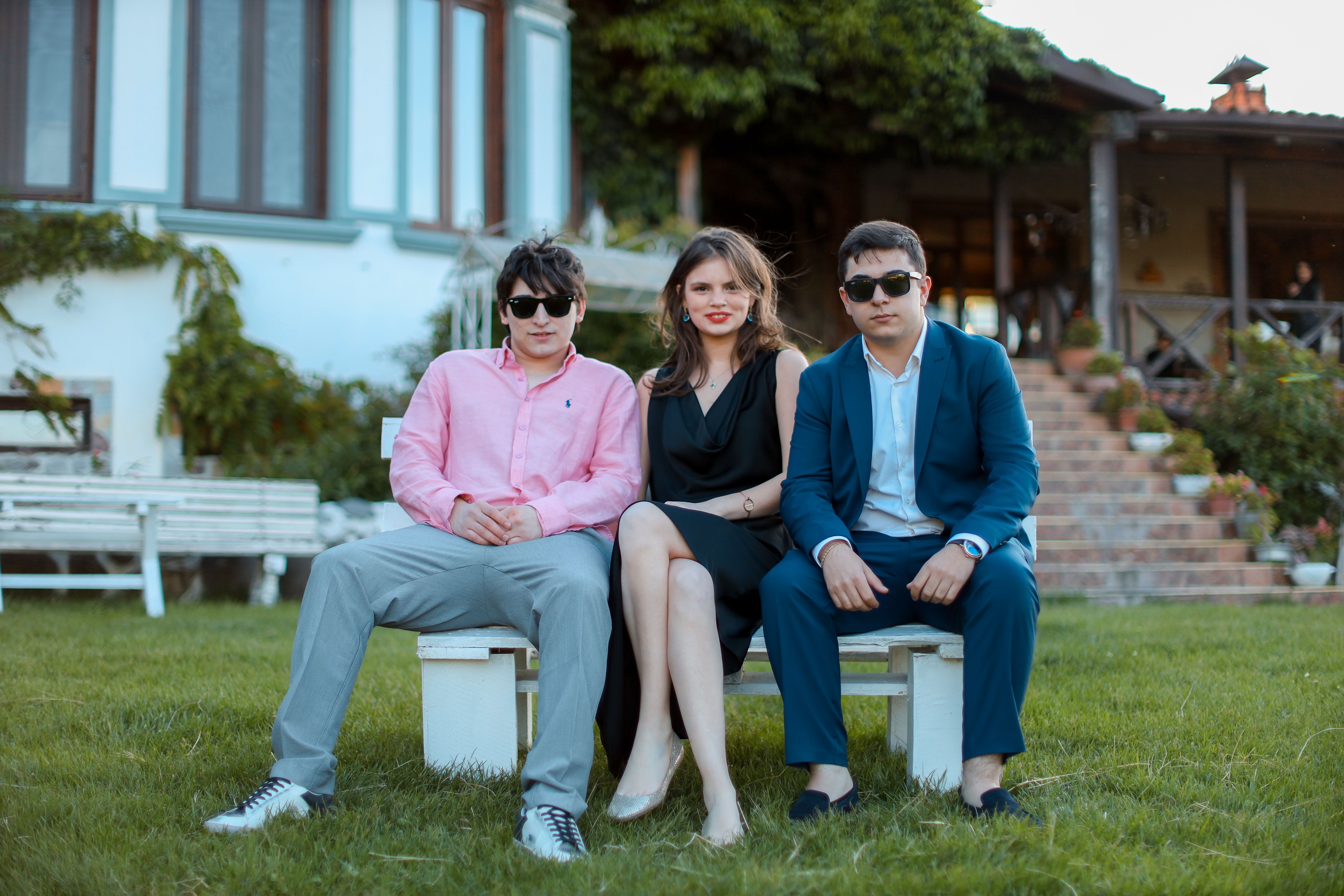 Well-Dressed Friends Sitting Together on a Bench · Free Stock Photo