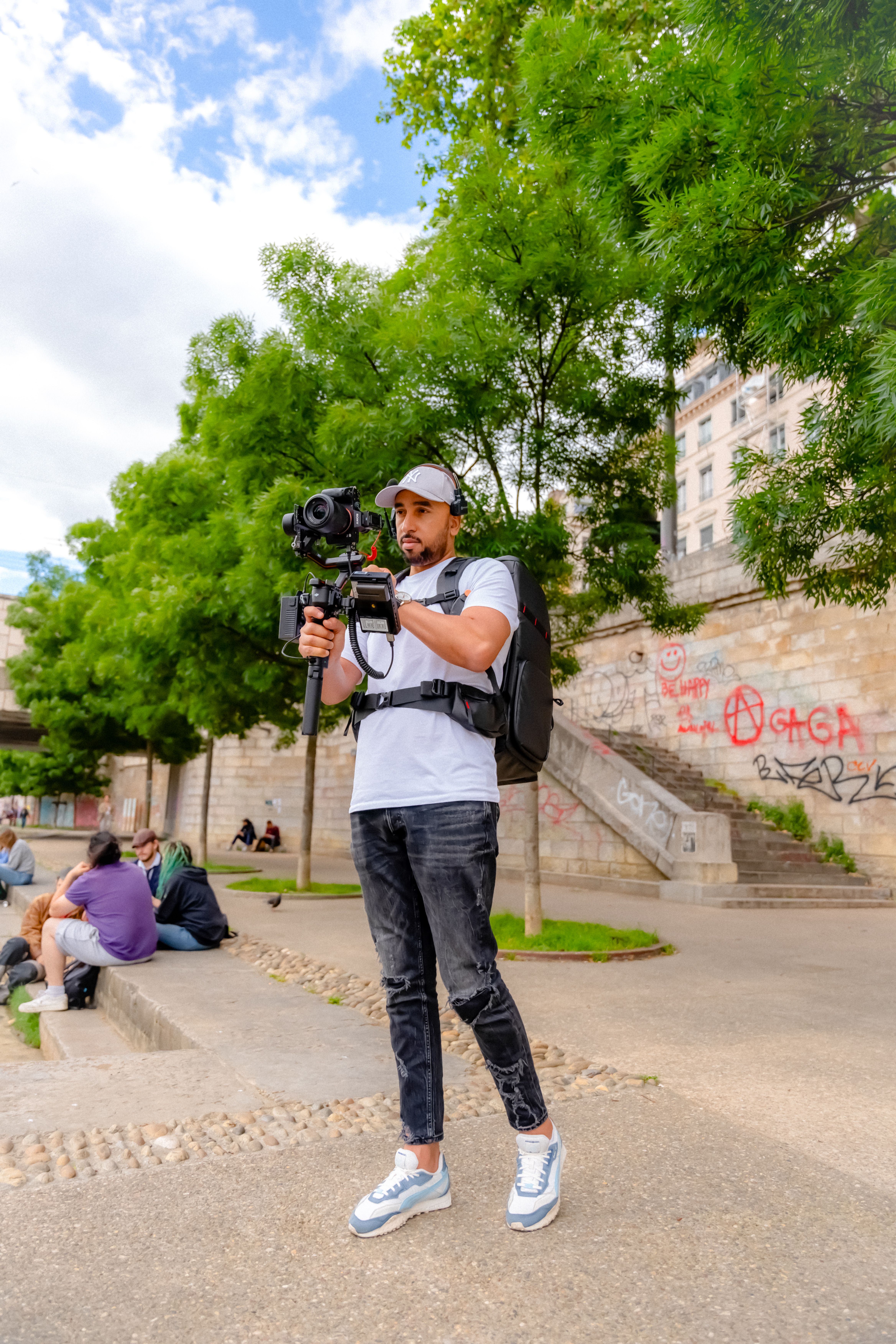 Man Recording Video with Camera on Tripod in Park · Free Stock Photo