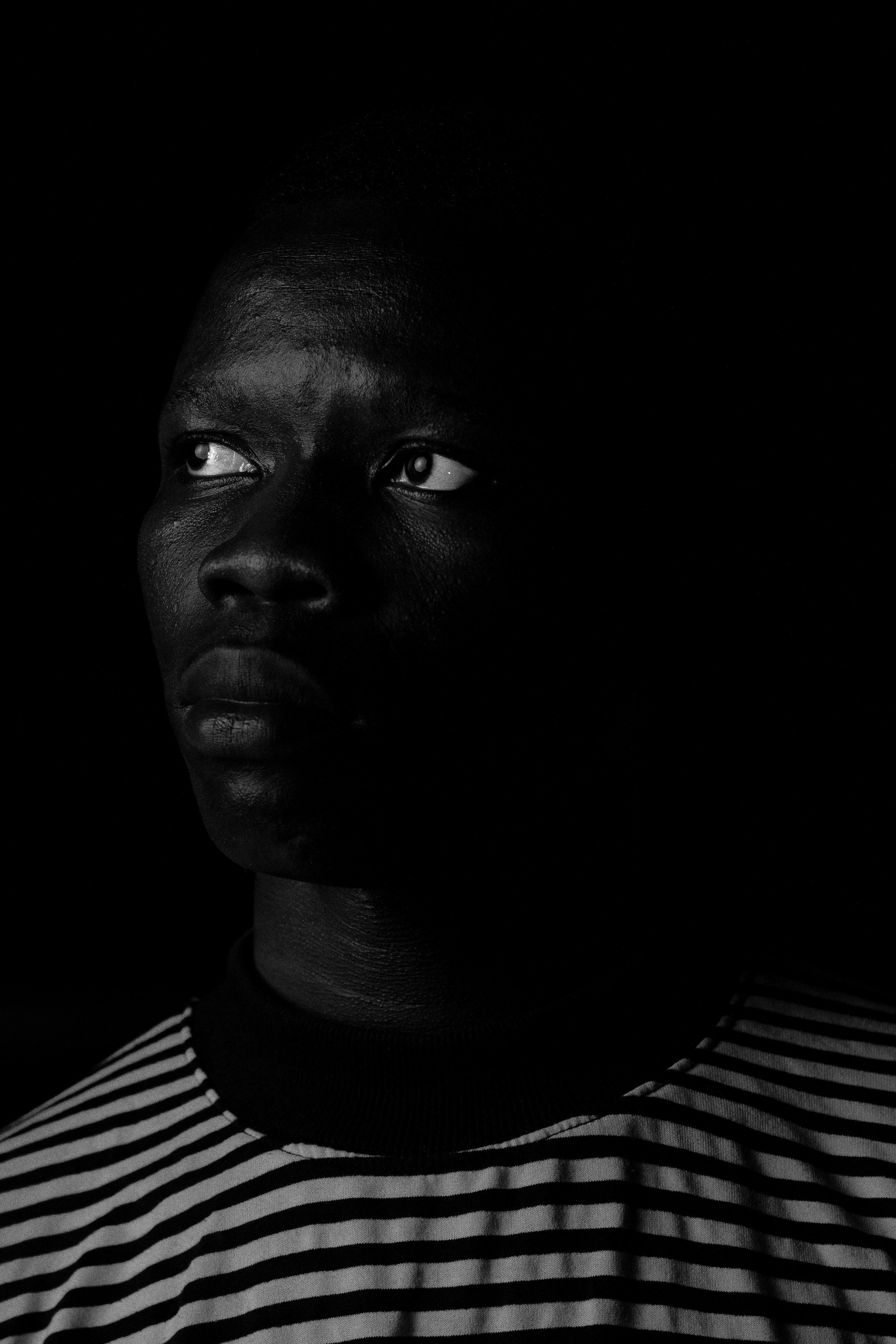 Portrait of an African Man in Shadow in Black and White · Free Stock Photo