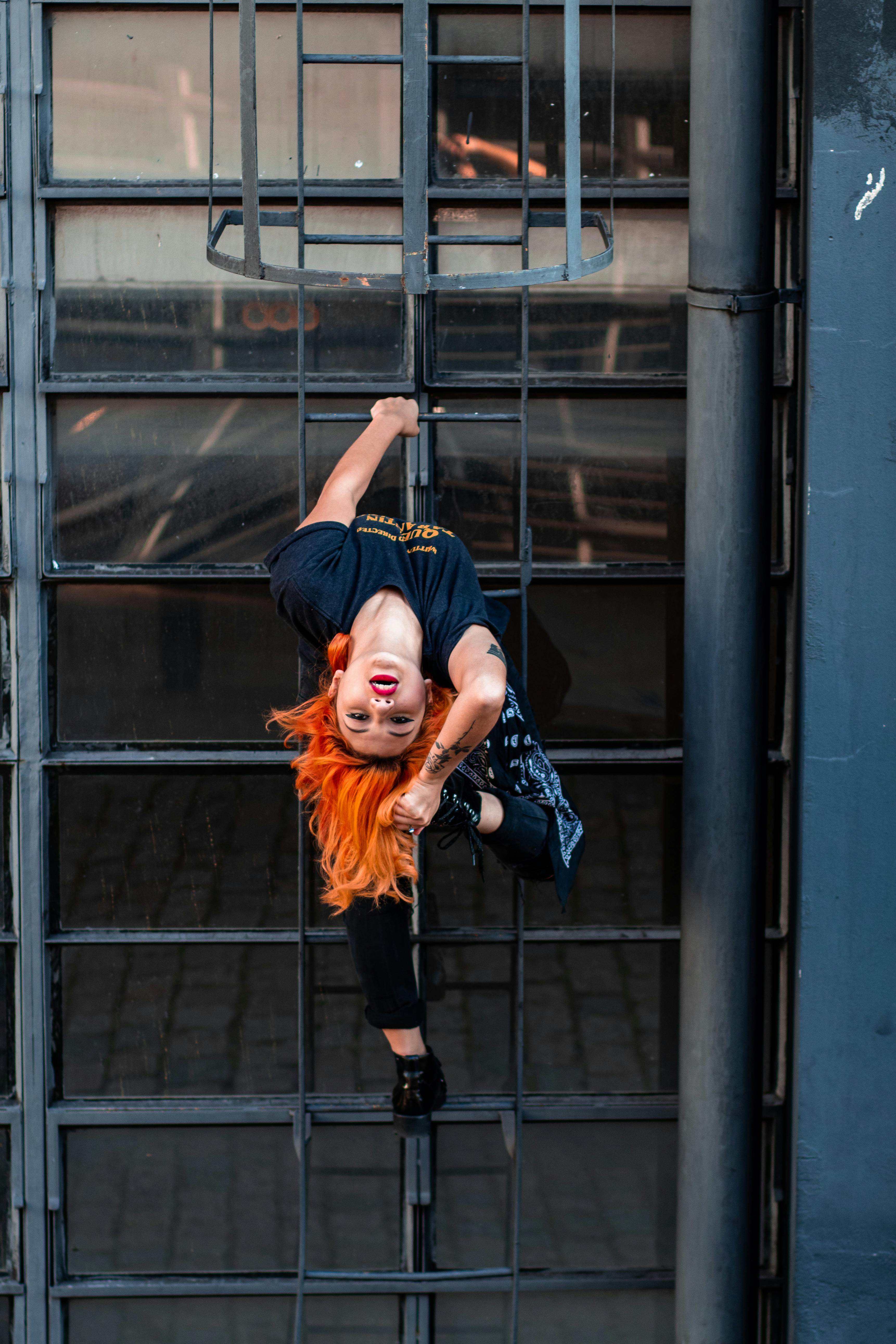 Photo of Woman Bending While Climbing on Ladder · Free Stock Photo