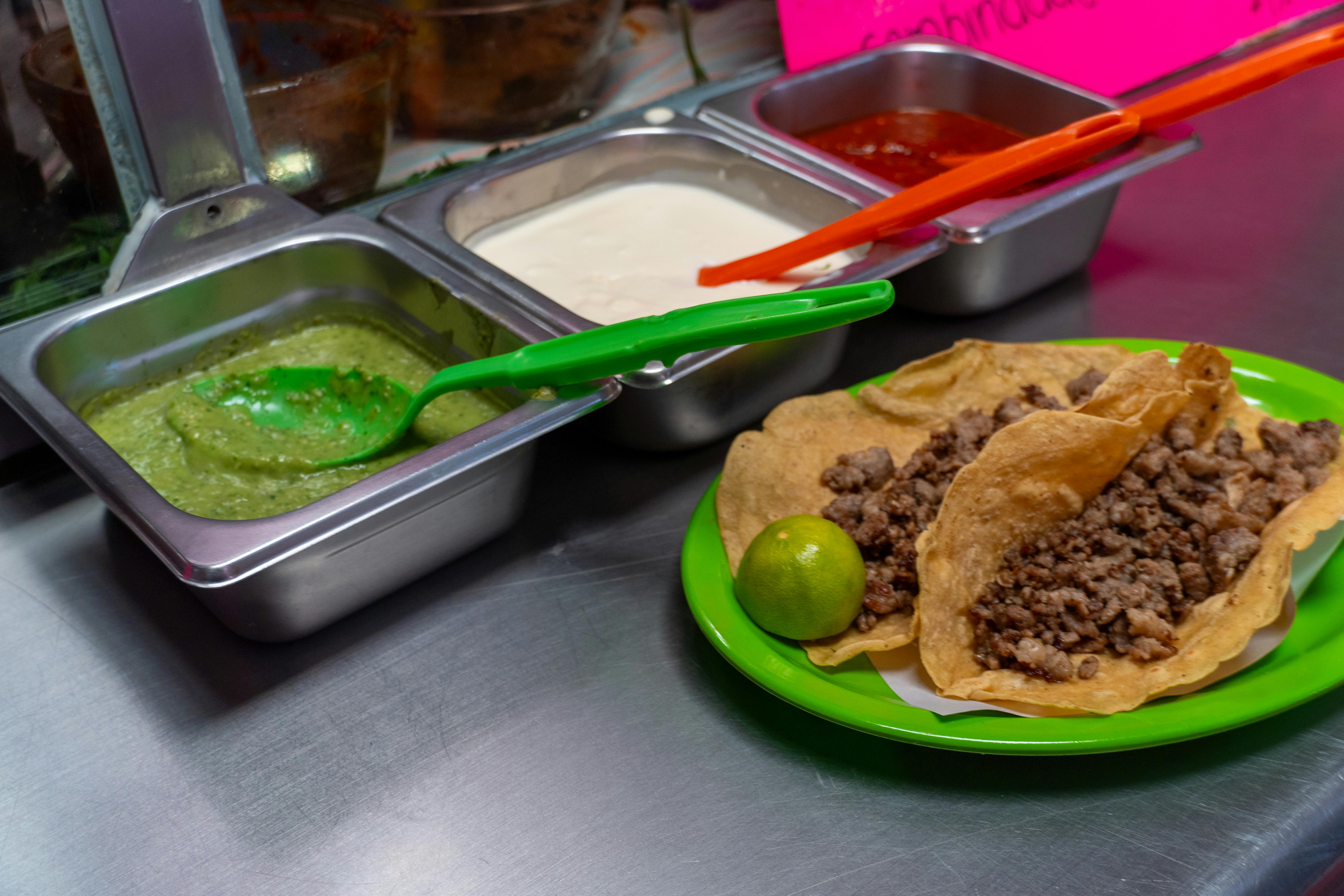 A plate of tacos and salsa on a counter · Free Stock Photo