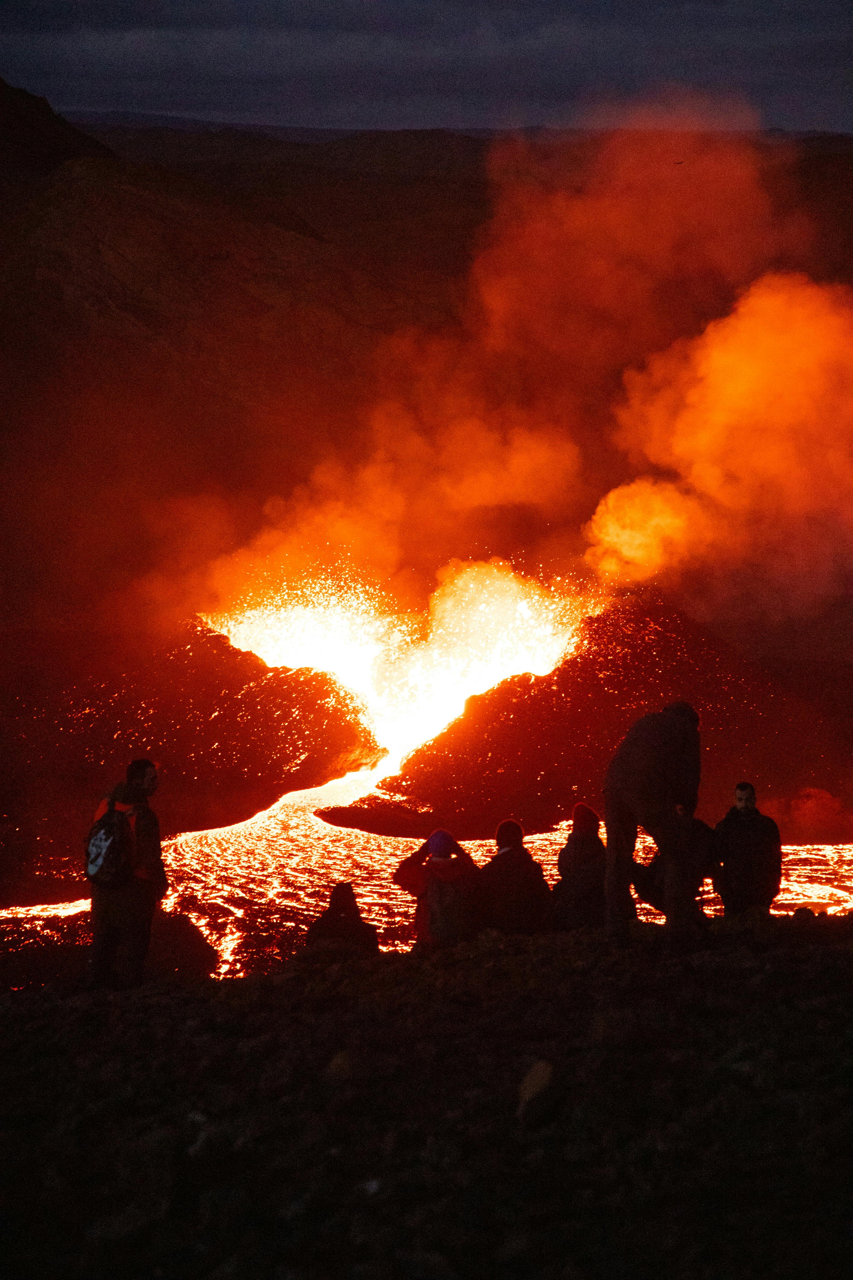 Burning Lava after Eruption behind People at Night · Free Stock Photo