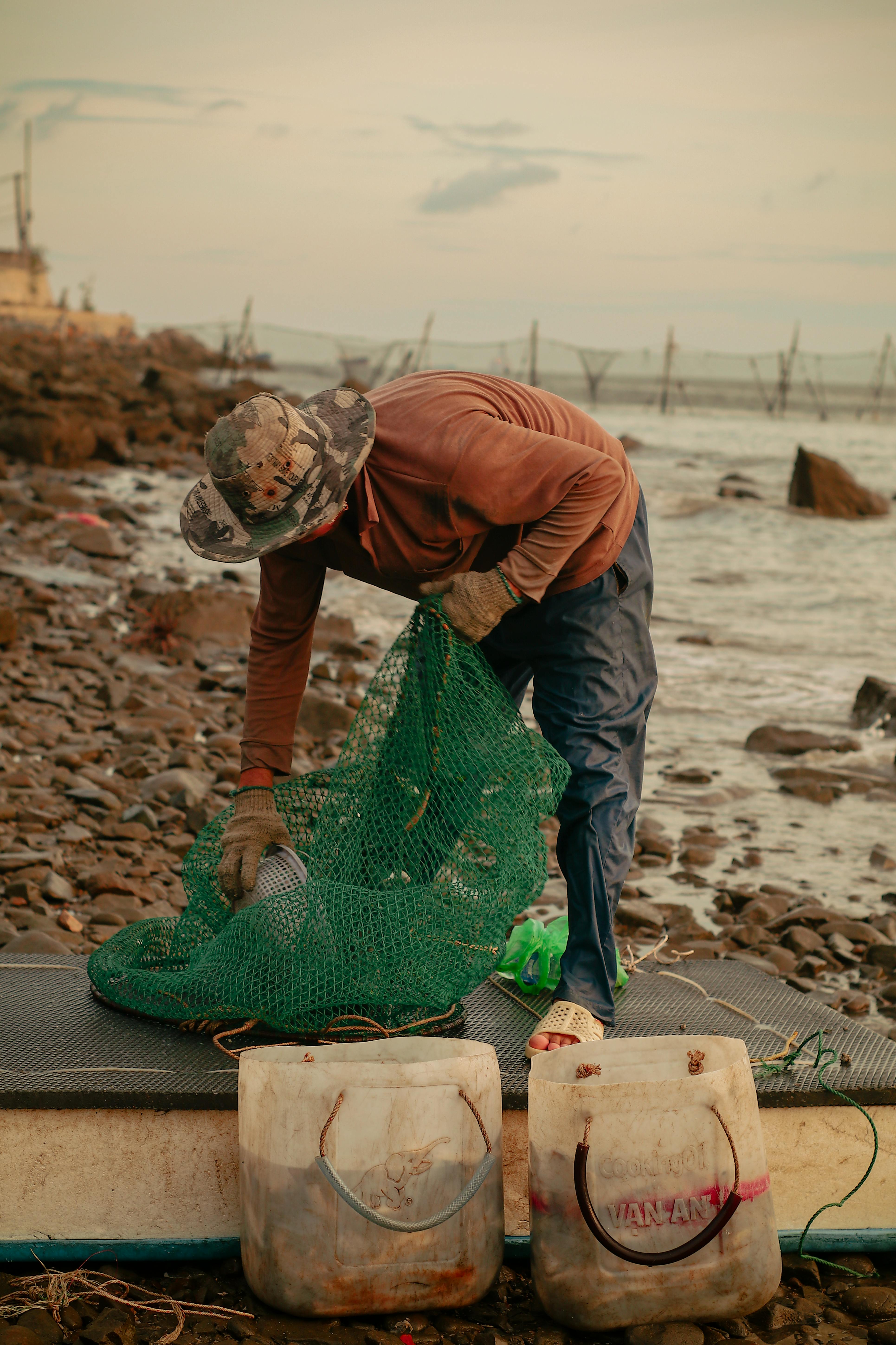 Fisherman with Net on Beach · Free Stock Photo