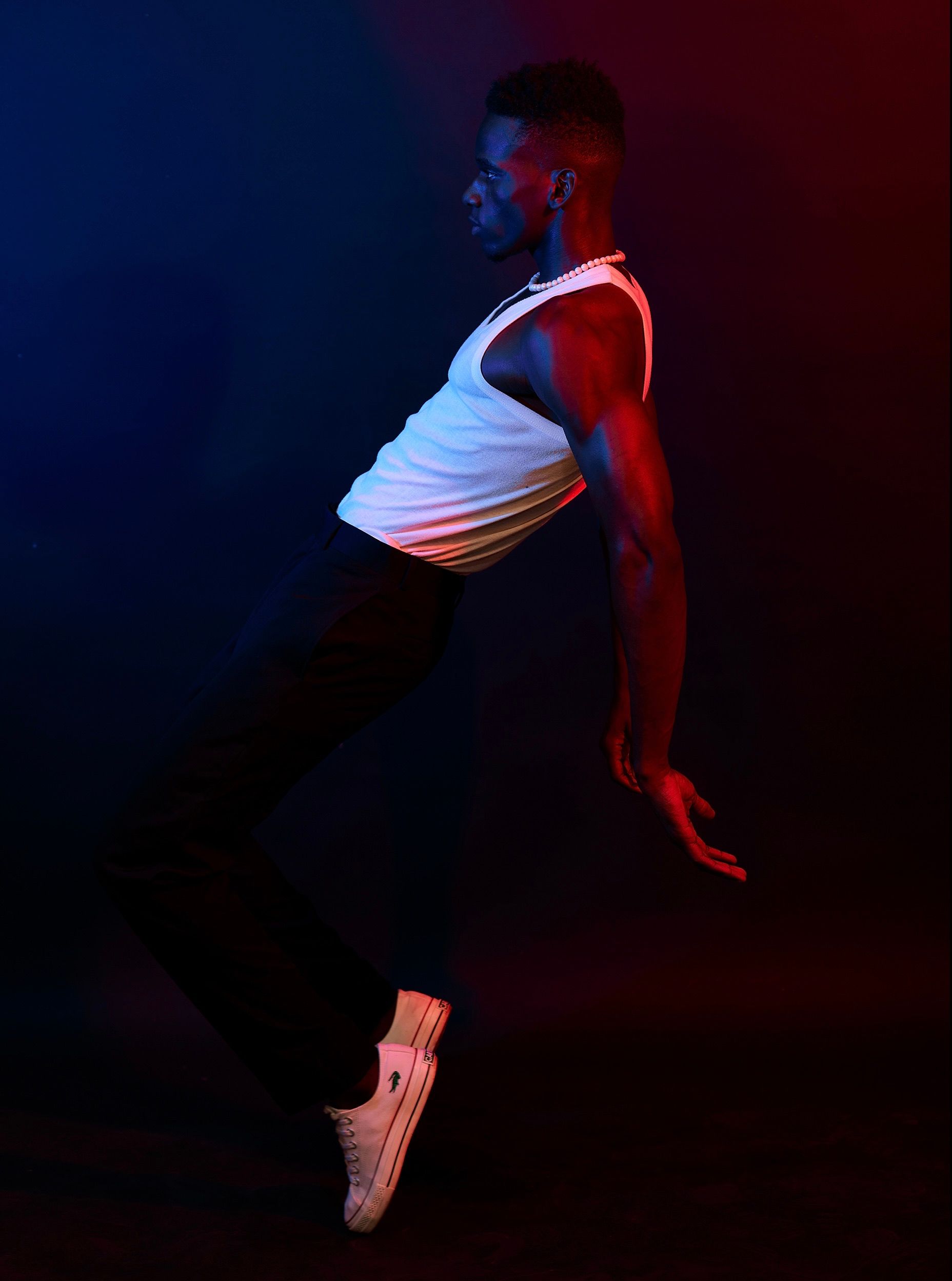 Studio Shot of a Man in a Dance Pose in Split Lighting · Free Stock Photo