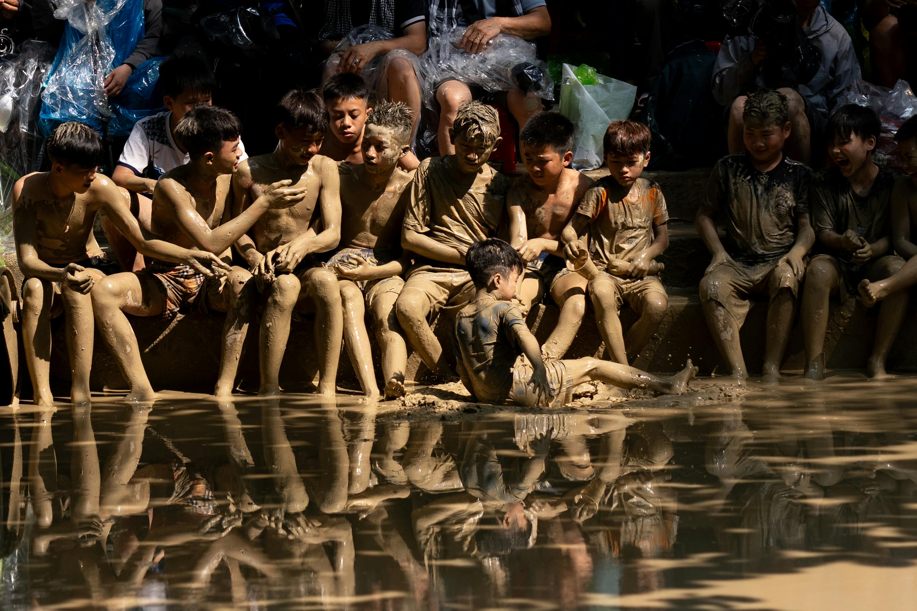 Mud Covered Boys Sitting at the Edge of a Pond · Free Stock Photo