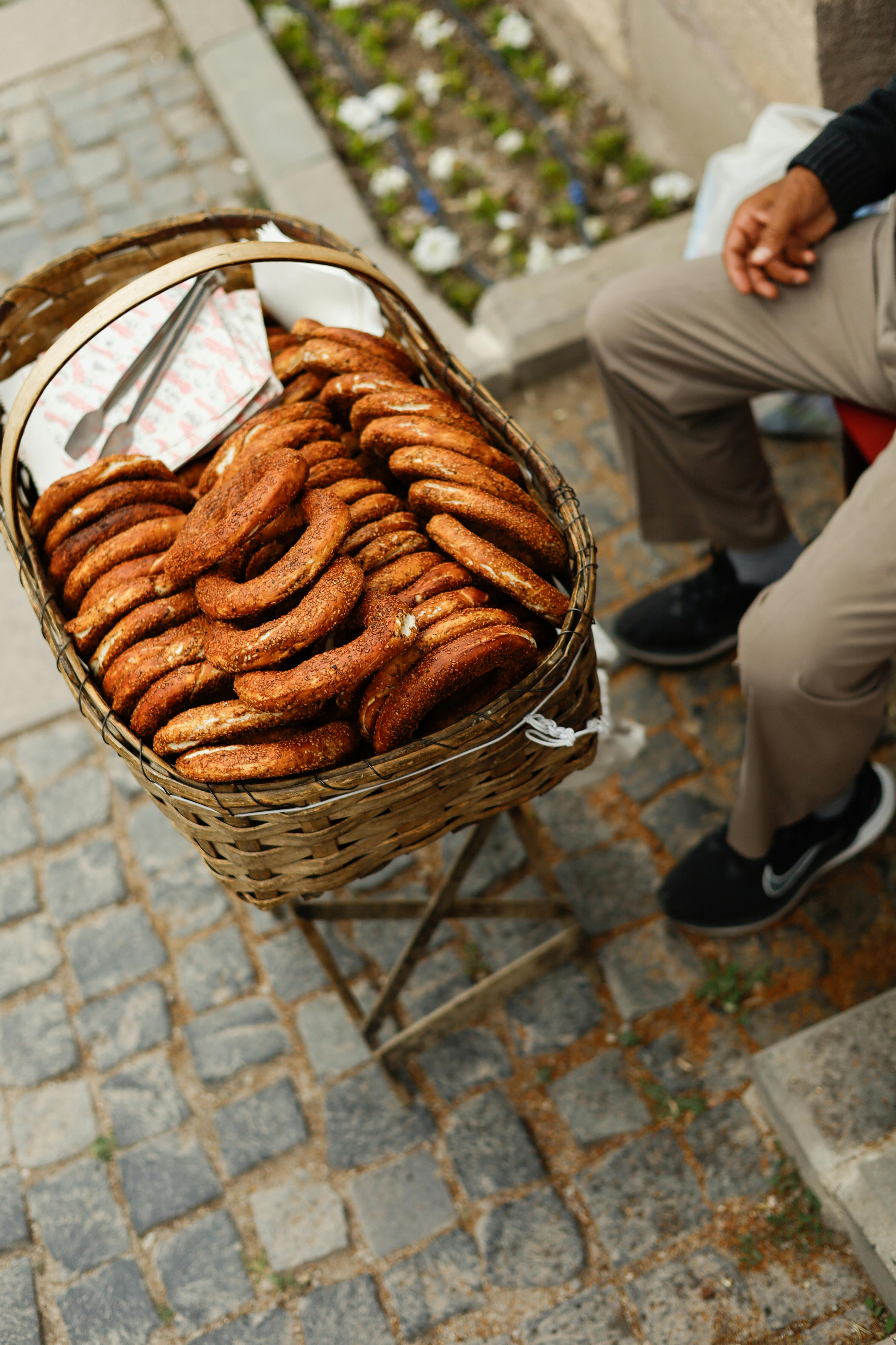 A Man Selling Traditional Simit Bread on the Sidewalk · Free Stock Photo