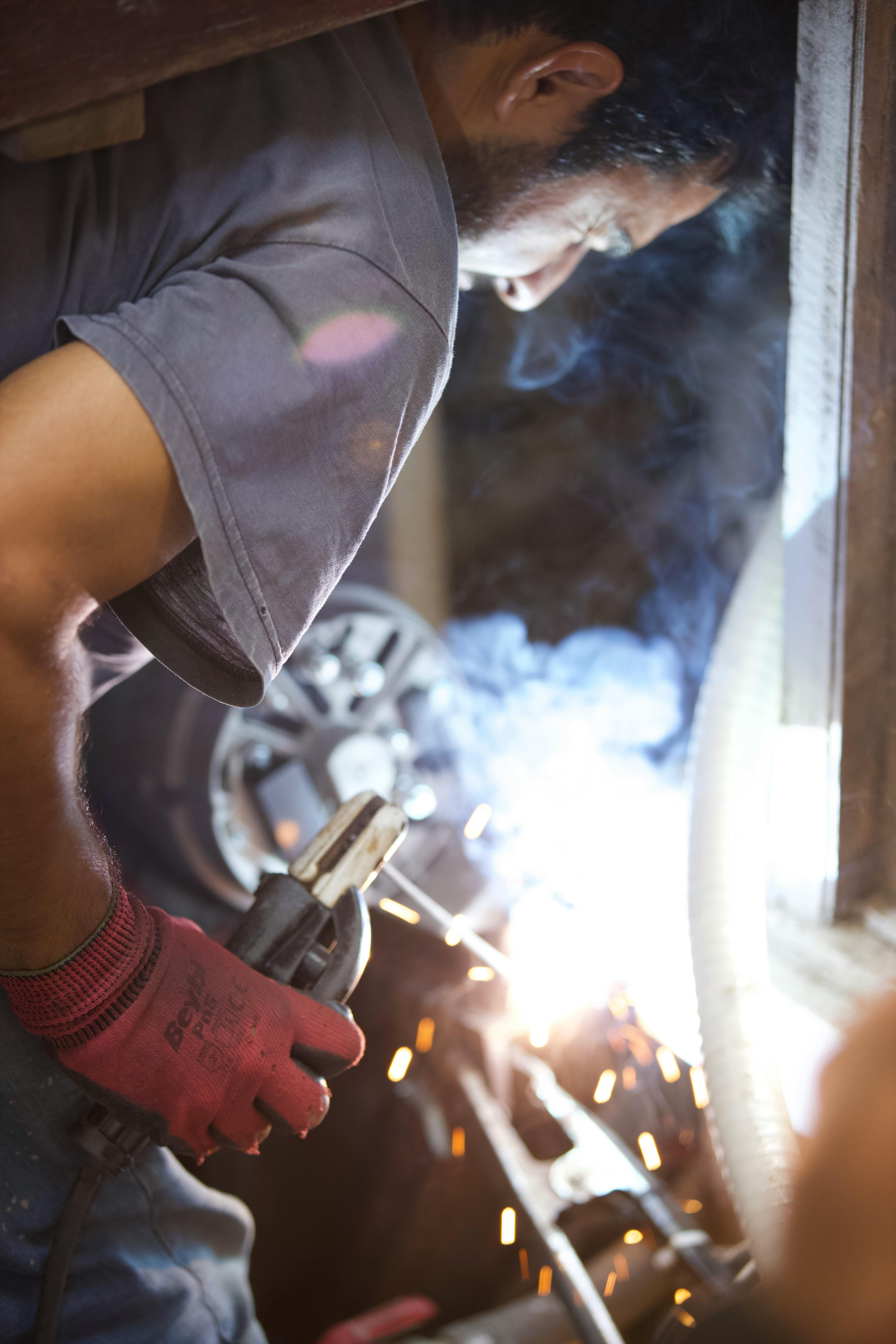 Photo of a Man Welding · Free Stock Photo