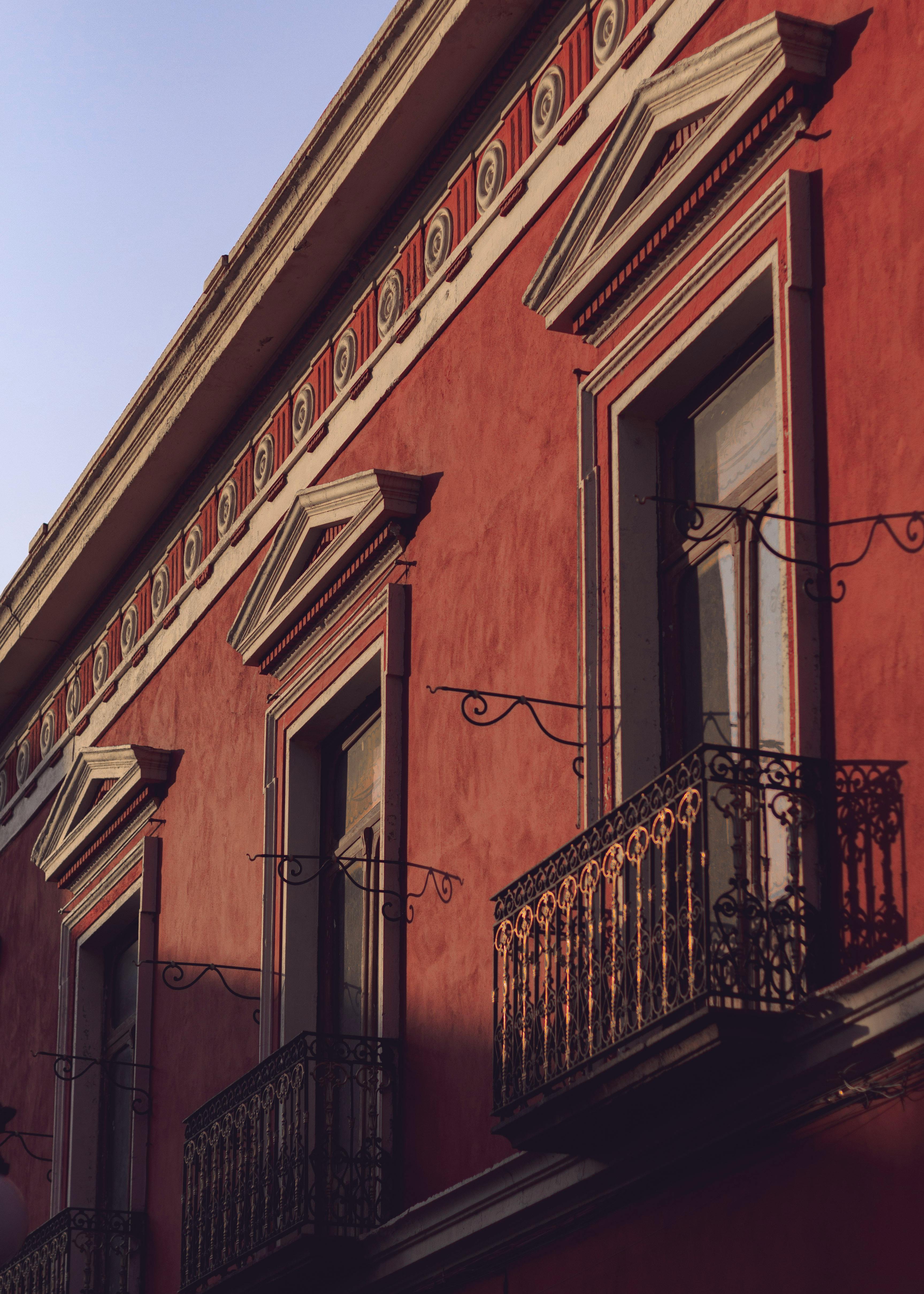 Facade of Red Classical Style Building with Balconies · Free Stock Photo