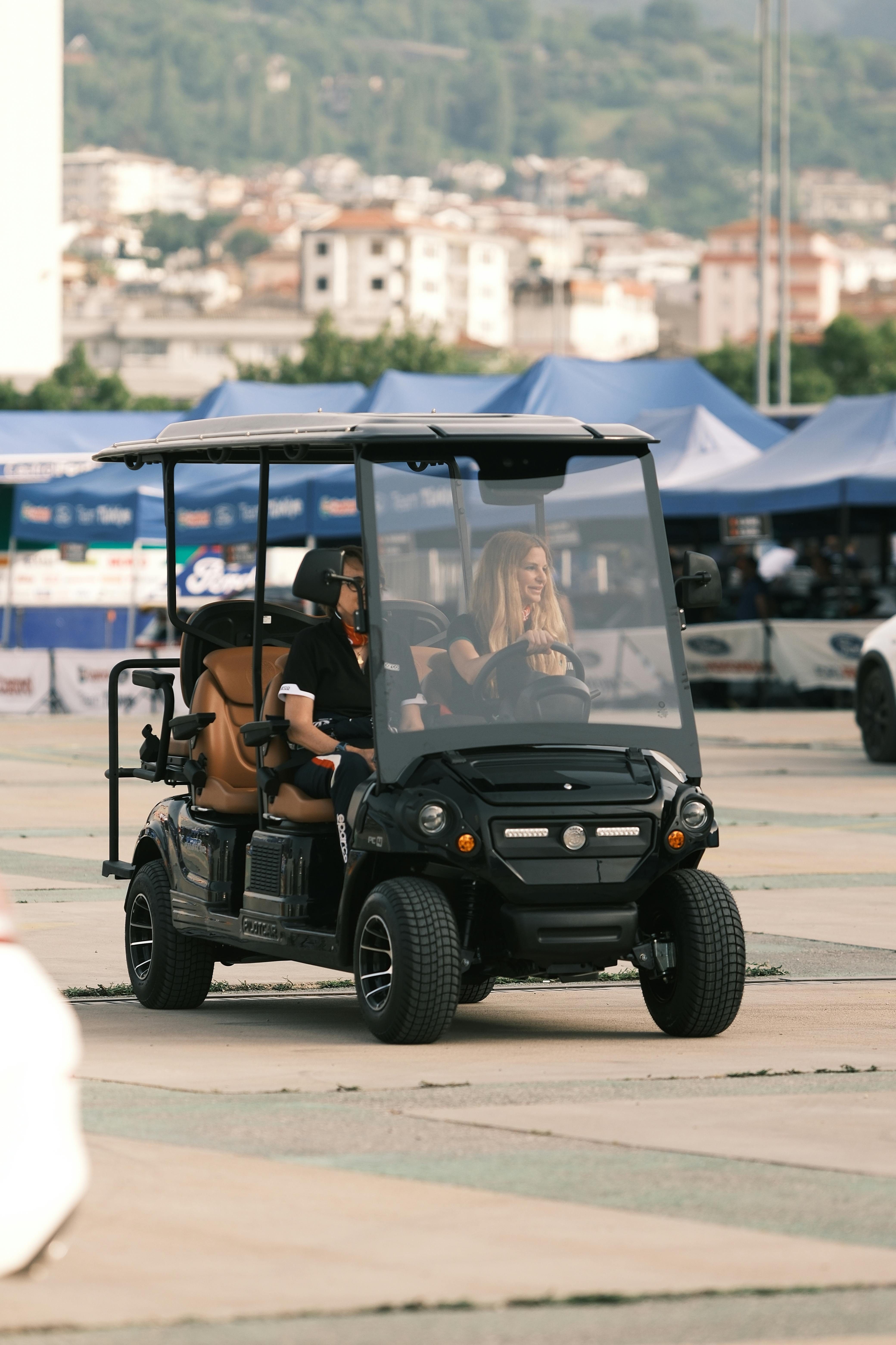 Blonde Woman Driving Golf Cart · Free Stock Photo