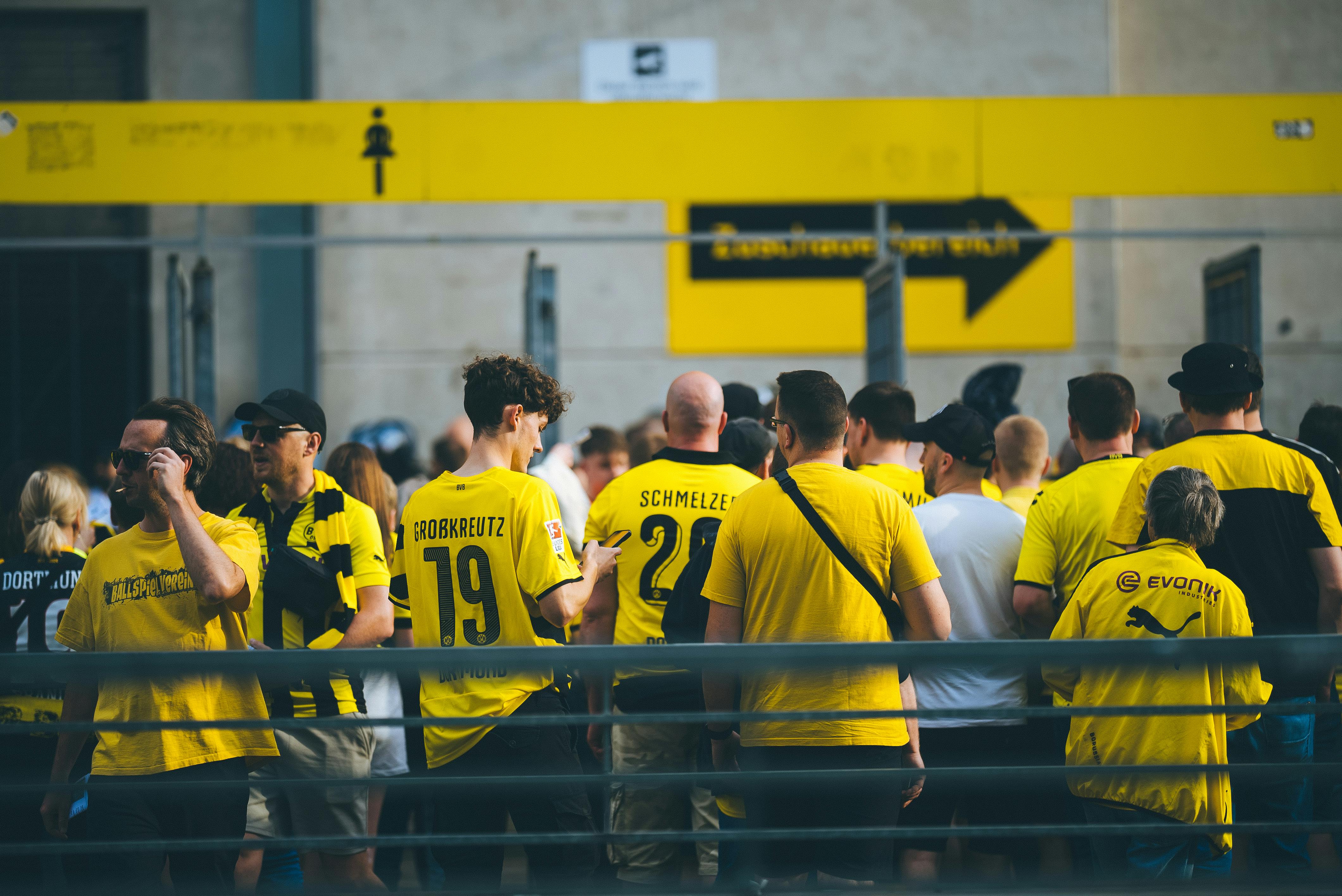 Back View of Borussia Dortmund Fans in Yellow T-shirts · Free Stock Photo