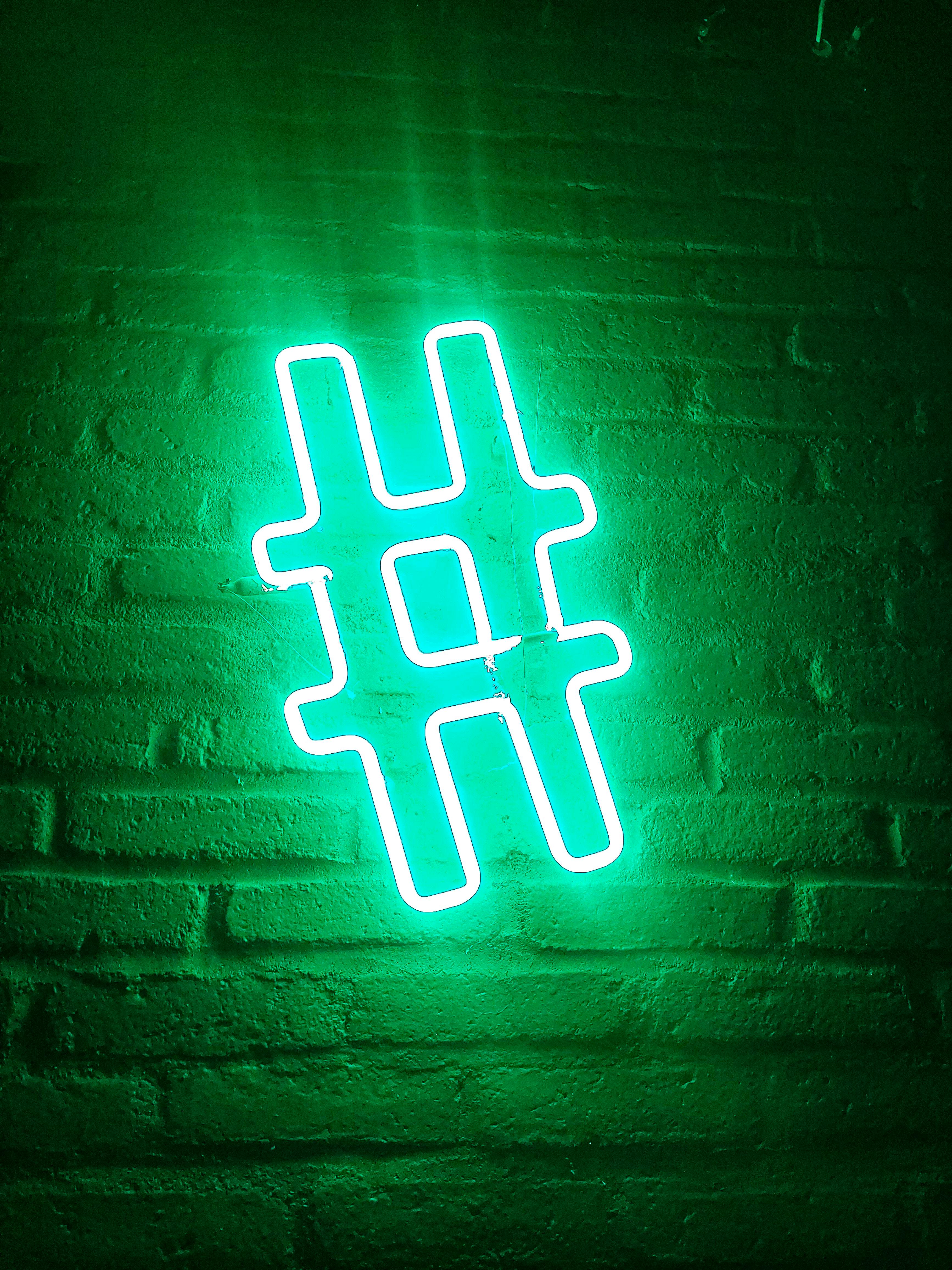 A neon green sign that says hash on it · Free Stock Photo
