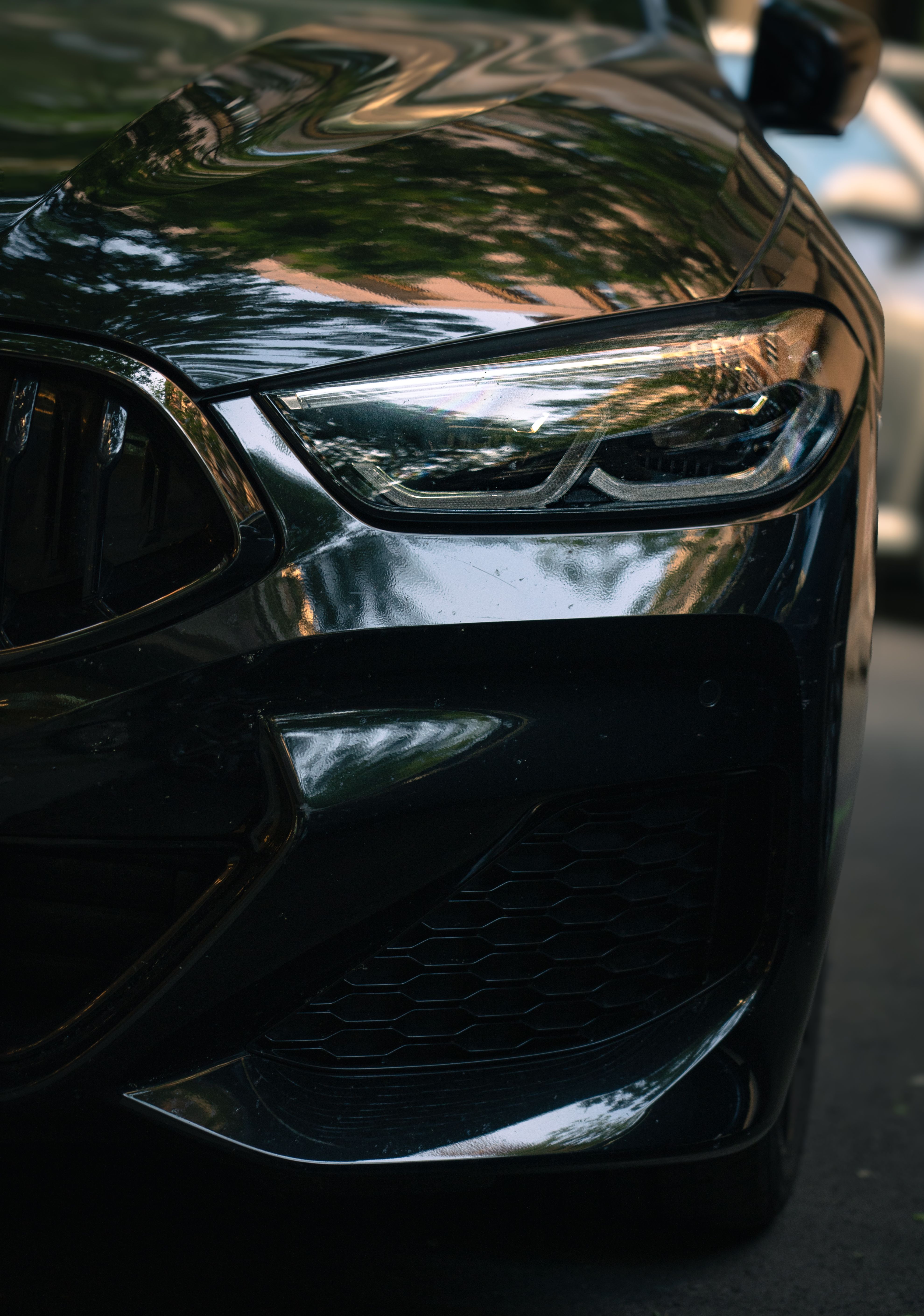 Closeup of the Front of a Modern Black Car · Free Stock Photo