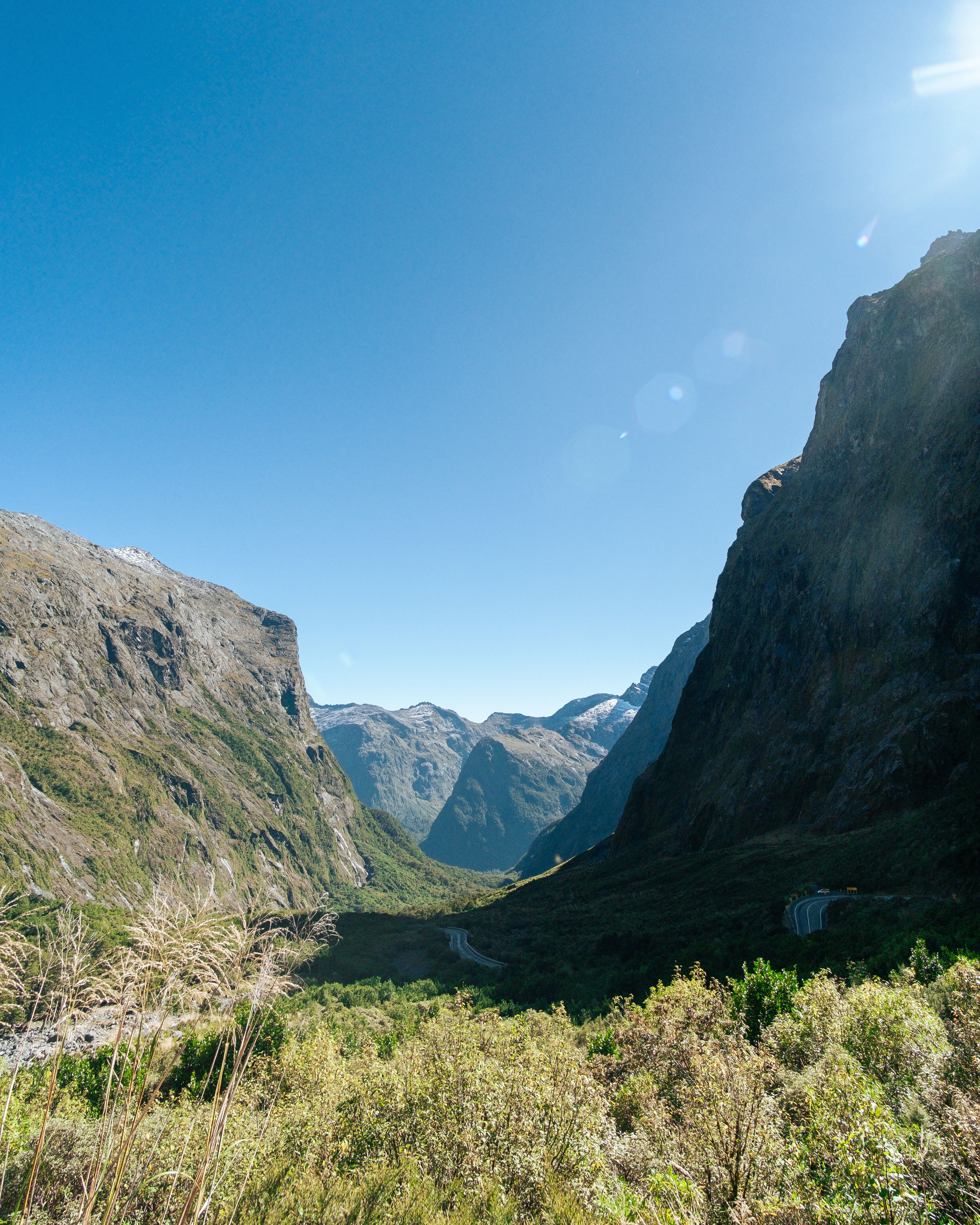 Road Through the Valley Between Steep Mountains · Free Stock Photo