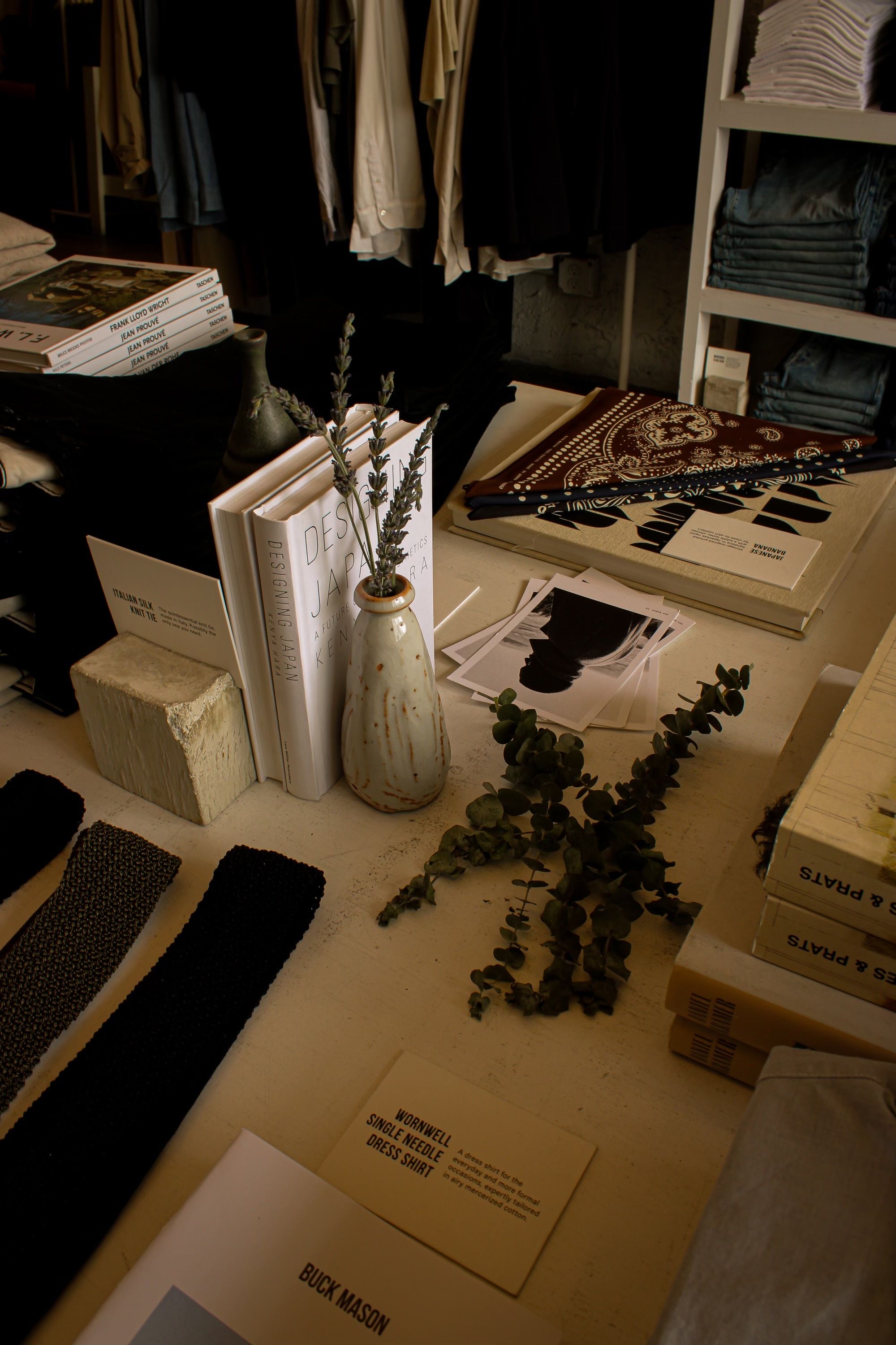A table with books, clothes and plants on it · Free Stock Photo