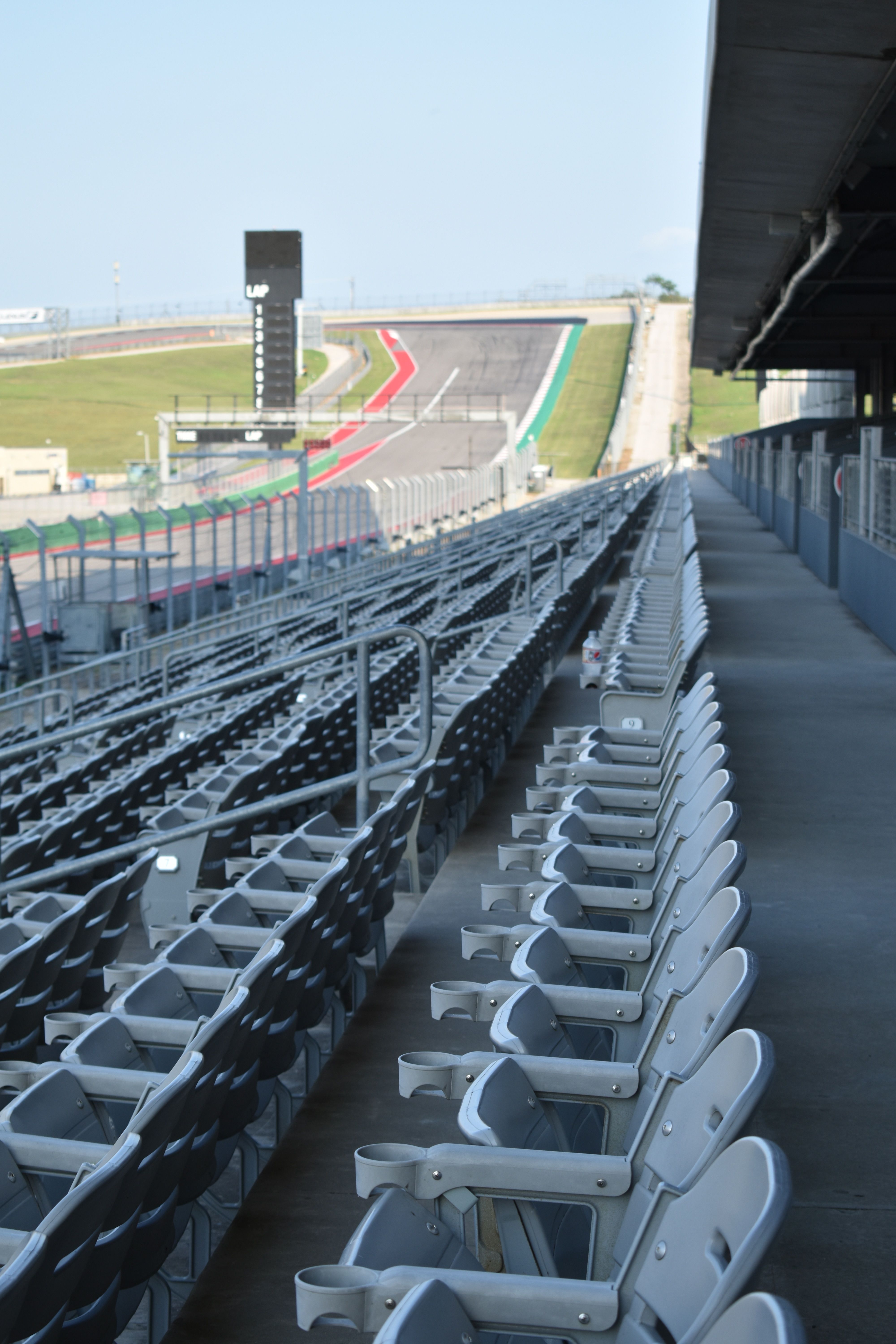 A row of empty seats at a race track · Free Stock Photo