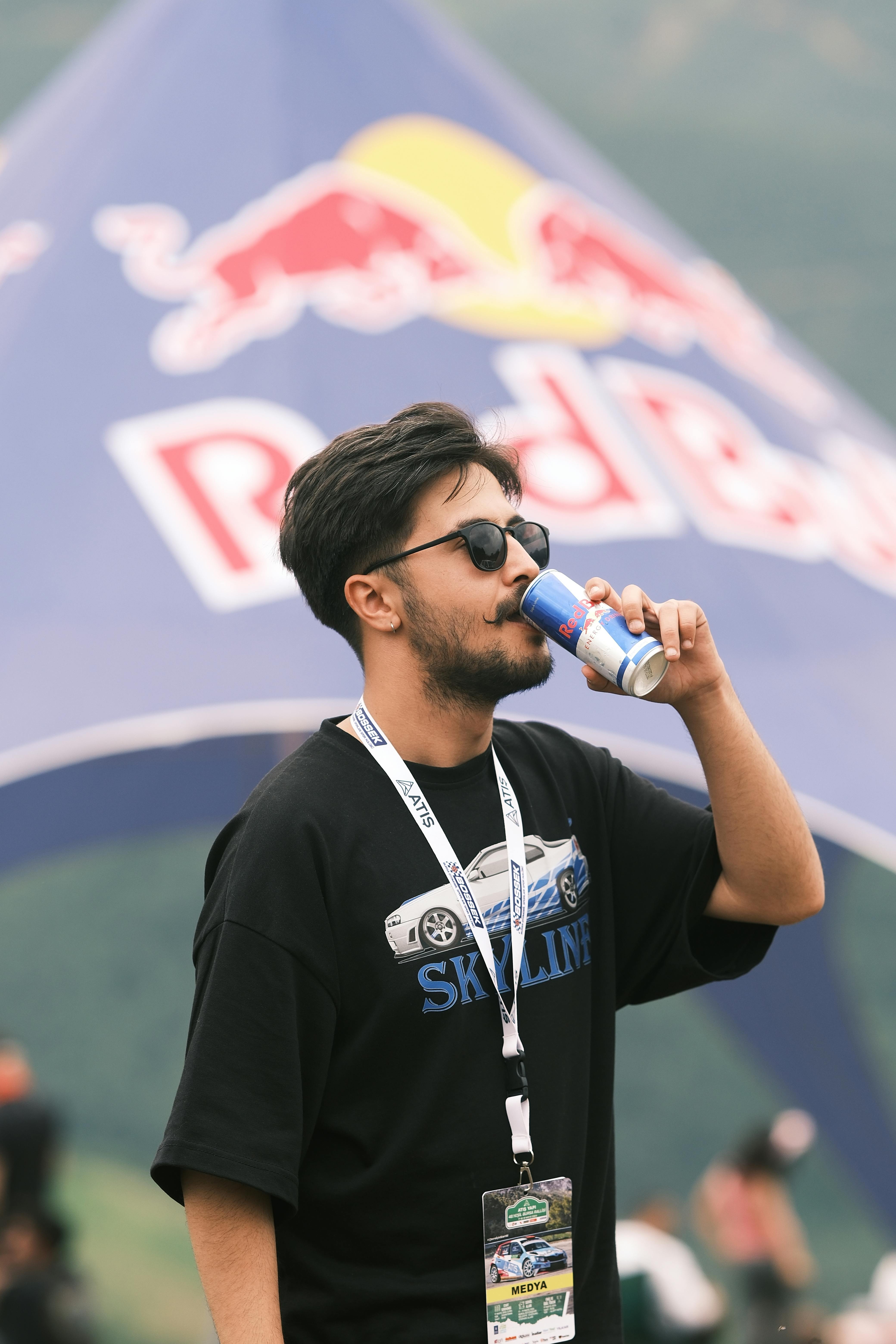 A man drinking Redbull · Free Stock Photo