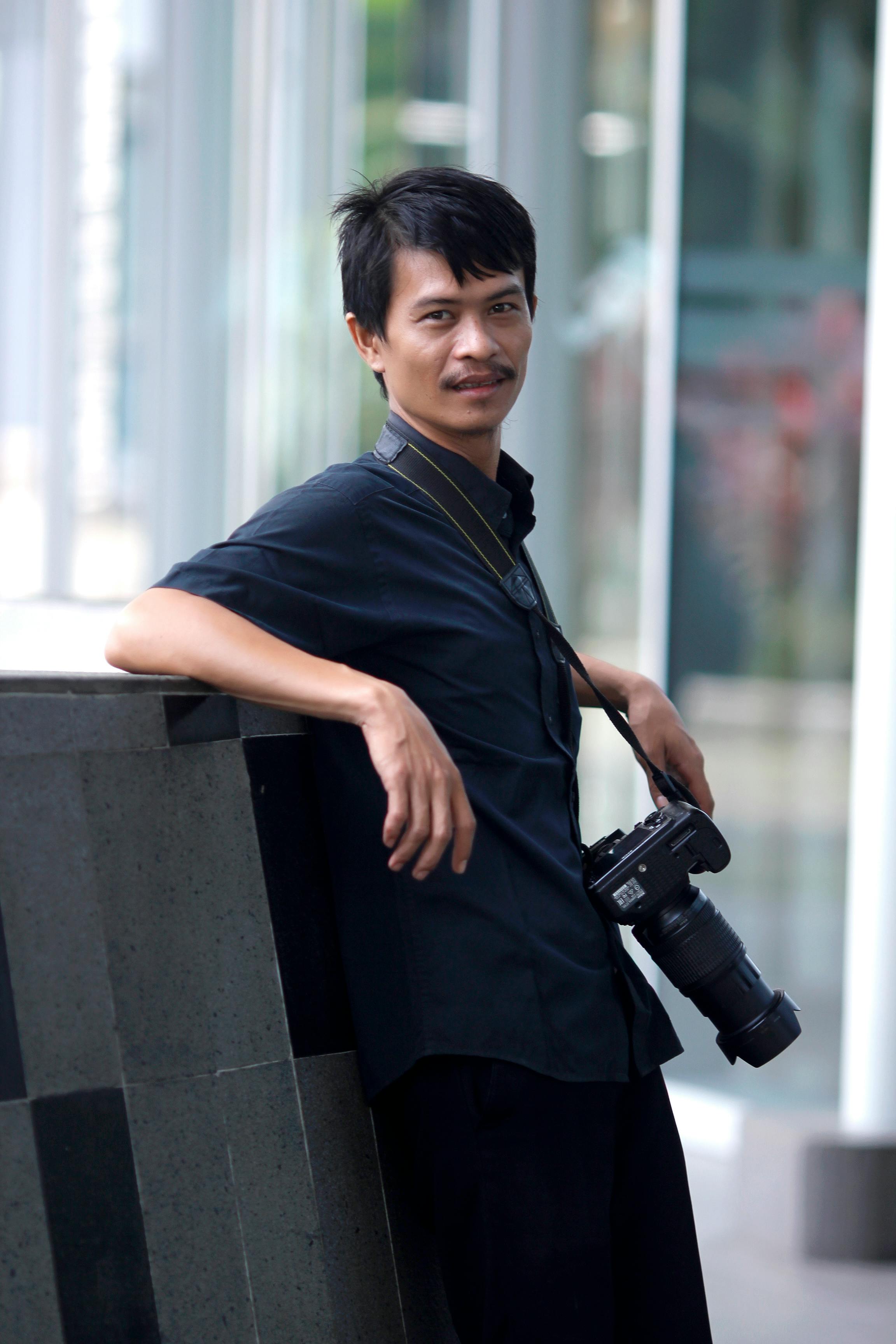 Man Posing with Camera around his Neck · Free Stock Photo