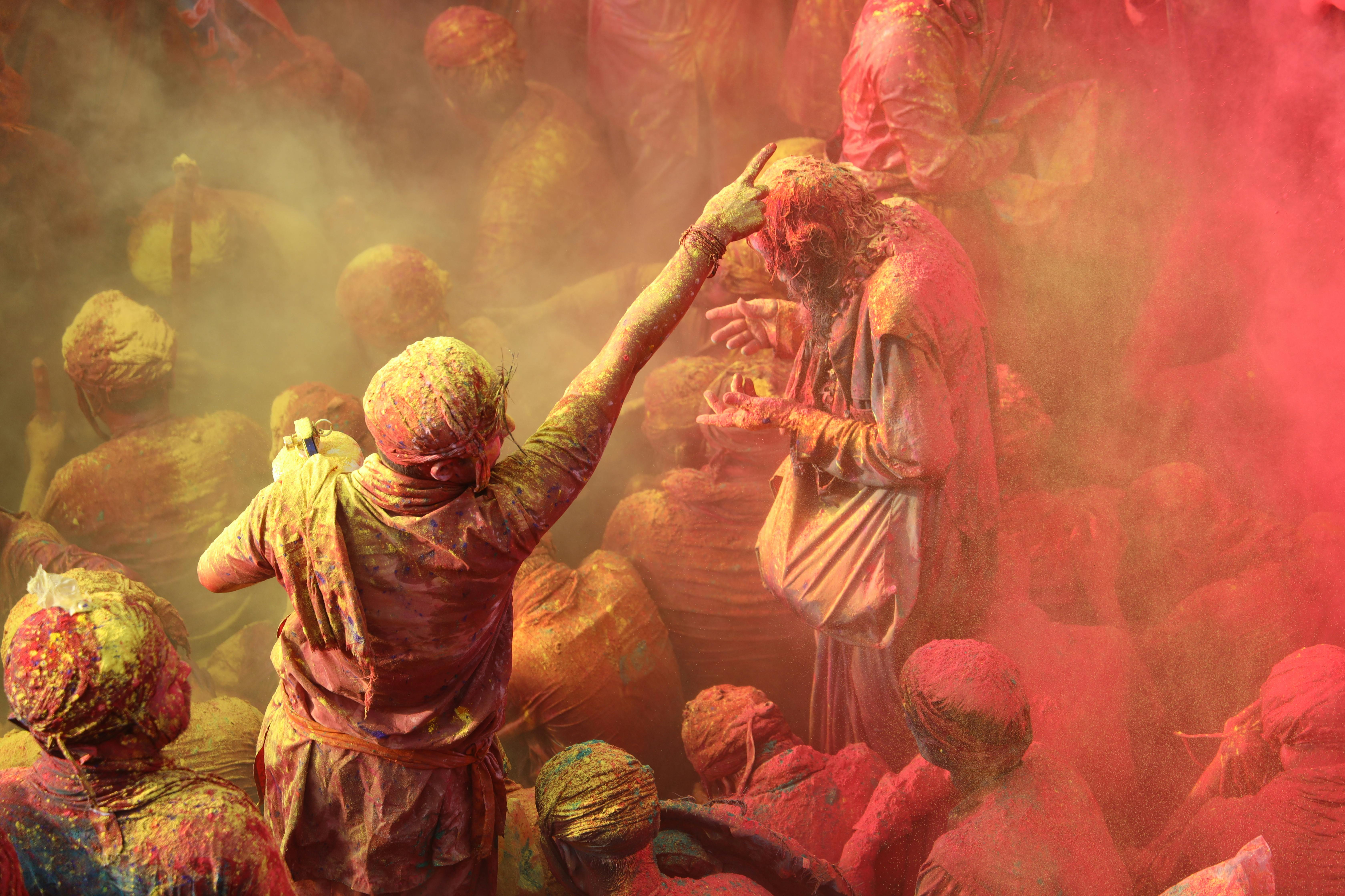 Person Throwing Colorful Powder into Crowd · Free Stock Photo