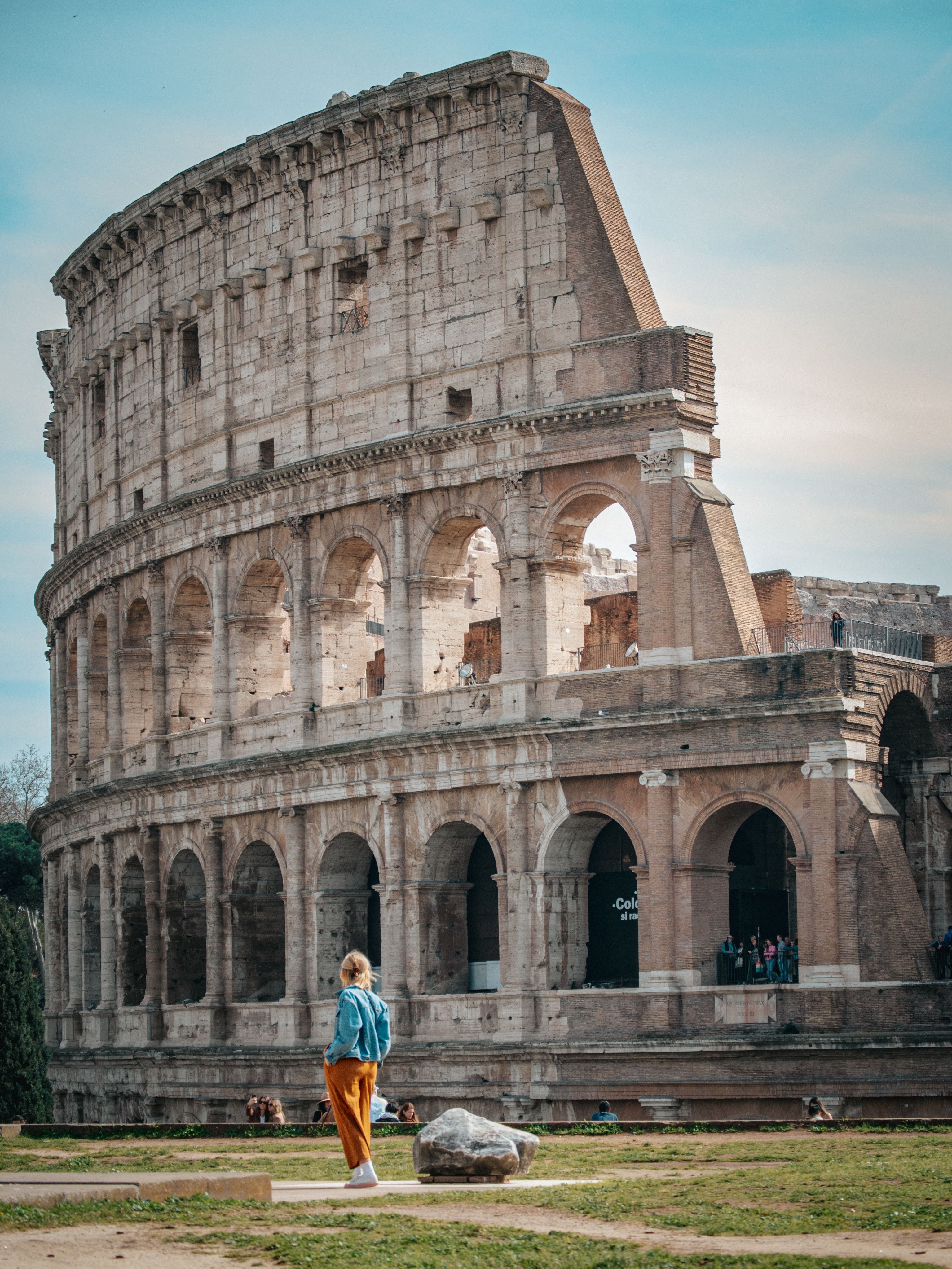Back View of a Woman Standing in Front of the Colosseum in Rome, Italy ...