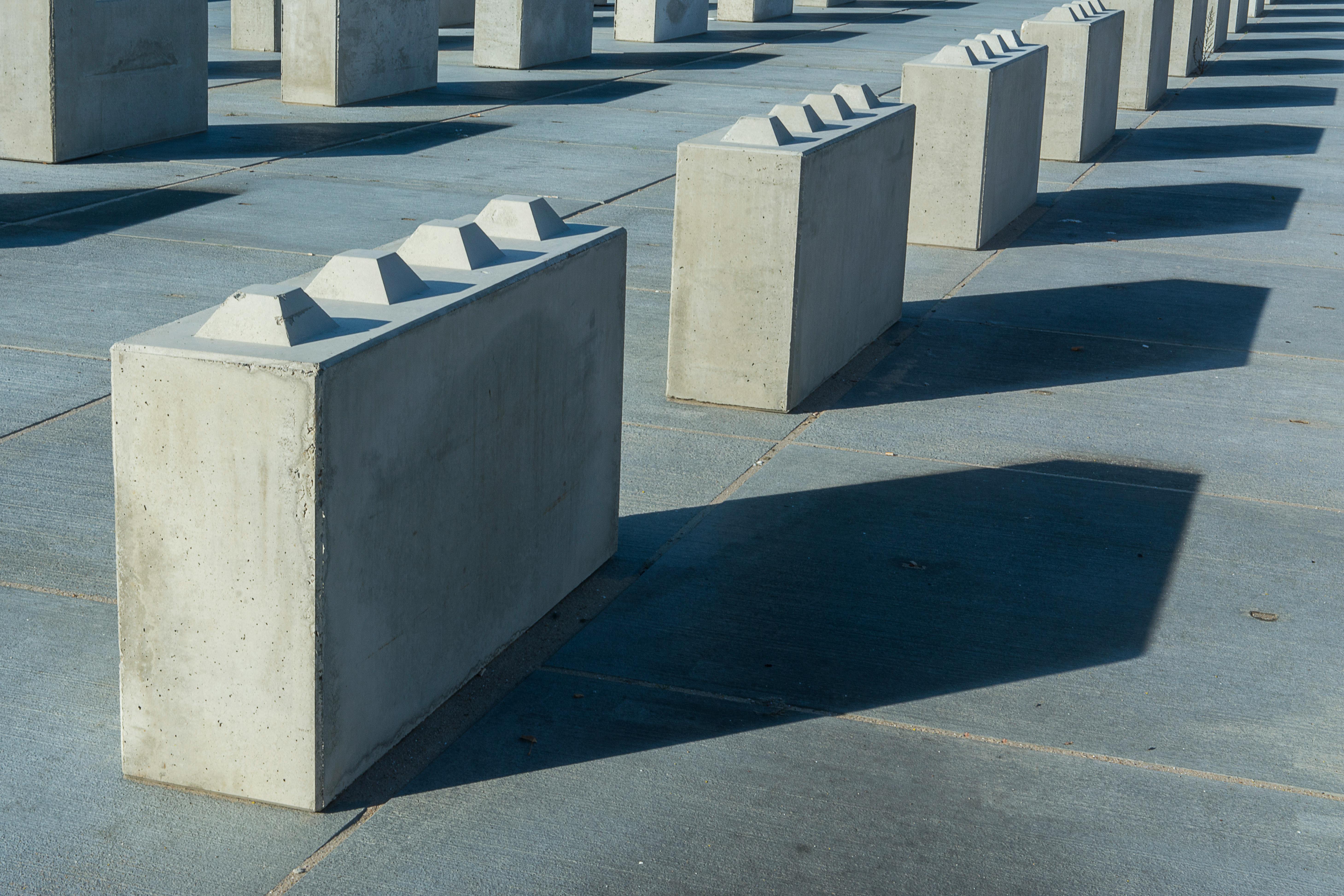 Concrete building wall with grid fence shadows · Free Stock Photo