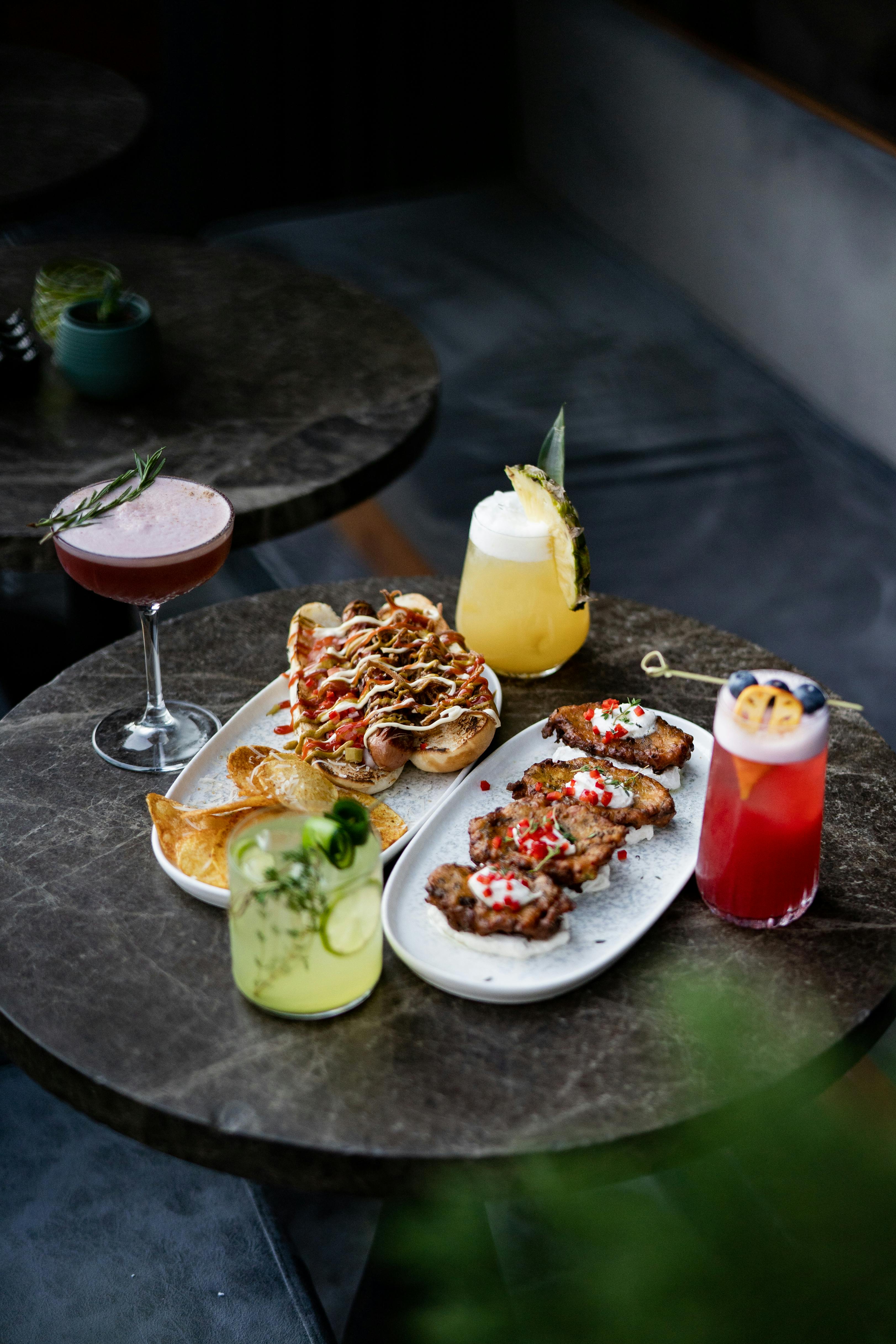 Dishes and Cocktails Standing on the Table in a Bar · Free Stock Photo